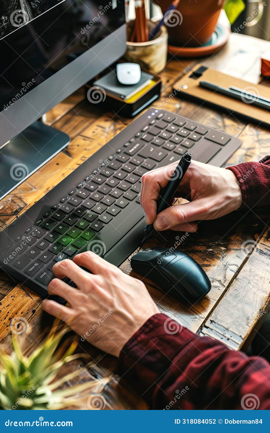 Graphic Designer Working with Digital Pen and Keyboard in a Modern ...