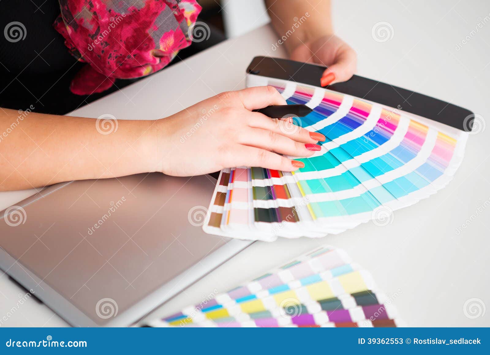 Graphic Designer Working on a Digital Tablet and with Pantone Stock ...