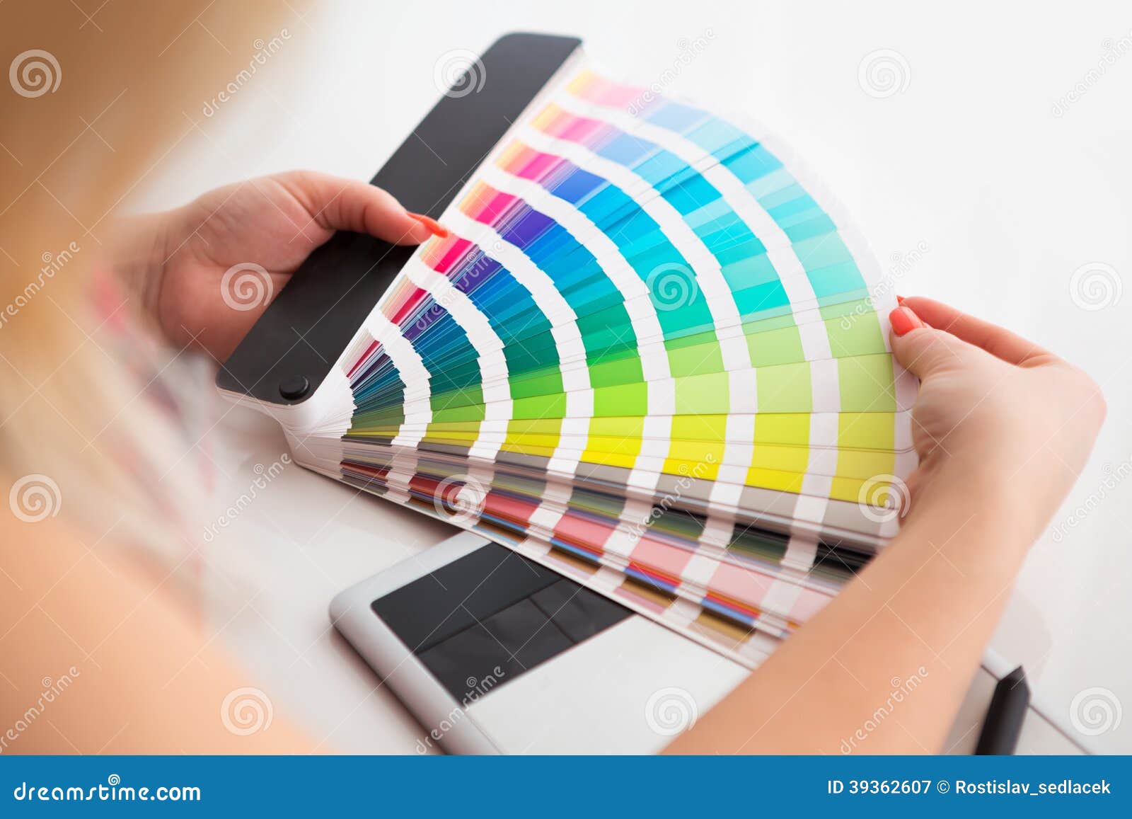 Graphic Designer Working on a Digital Tablet and with Pantone Stock ...