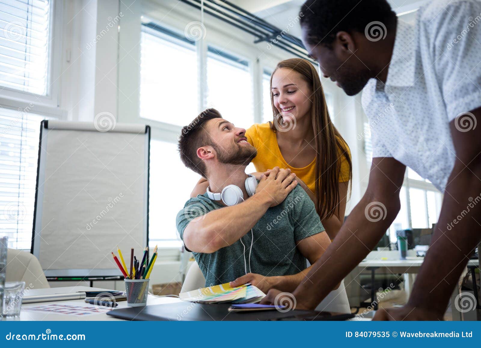 Graphic Designers Interacting at Their Desk Stock Image - Image of ...