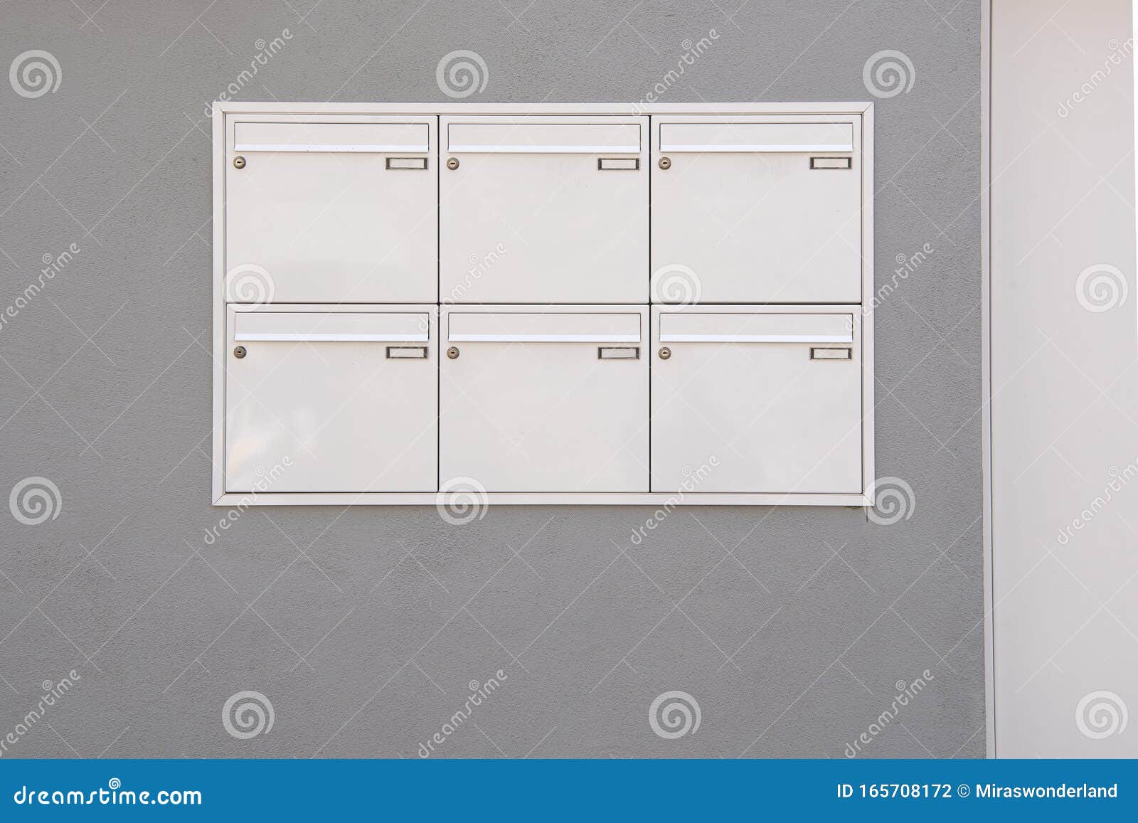 Graphic View of White Mailboxes on a Grey Wall of a House Stock Photo ...