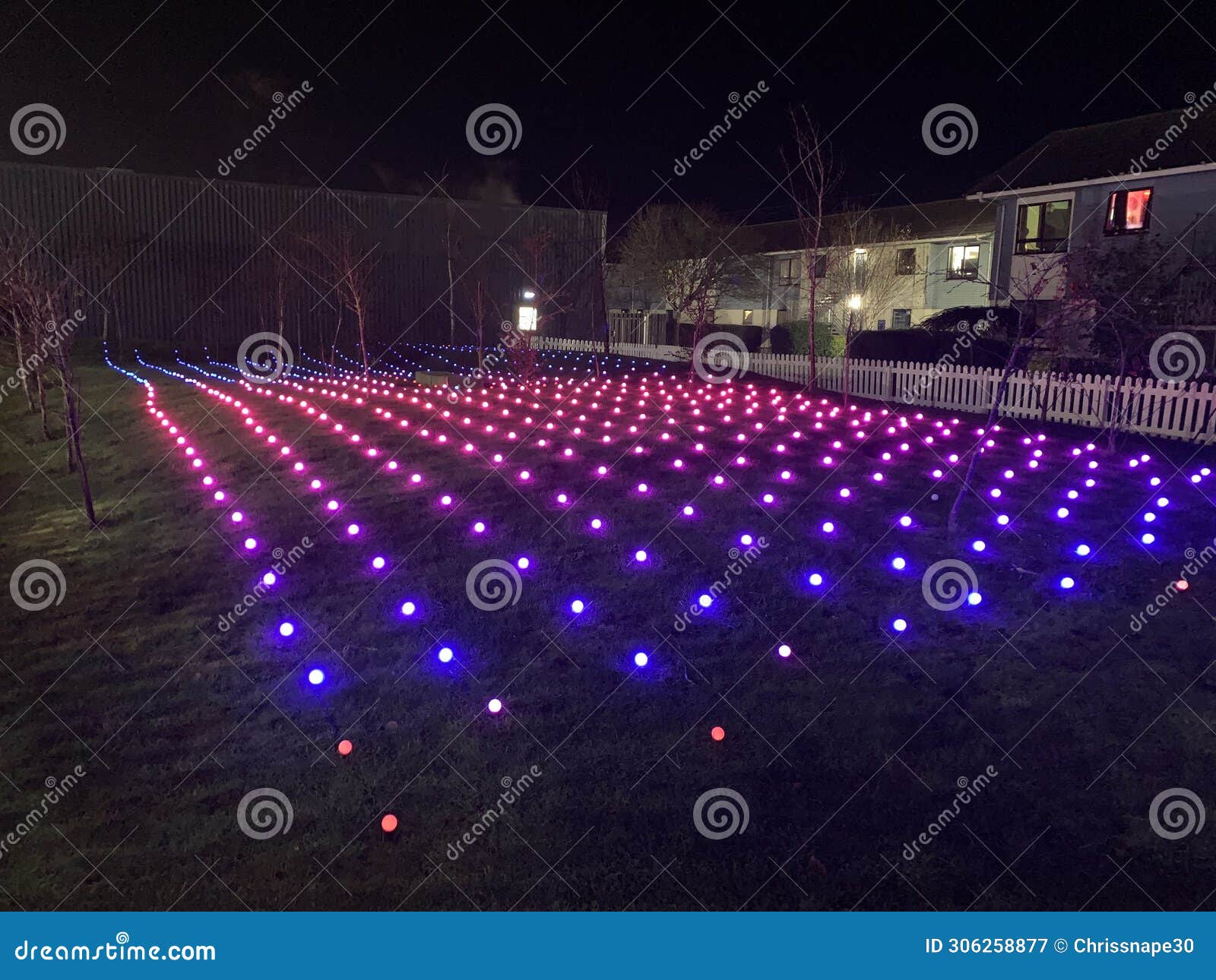 Grass Area at Night with Rows of Smart Multicoloured Circular LED ...