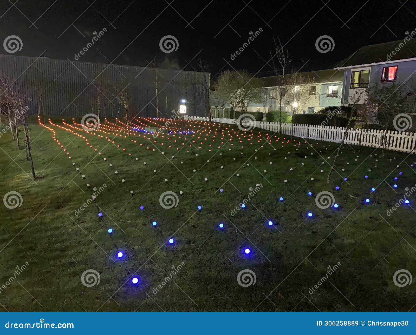 Grass Area at Night with Rows of Smart Multicoloured Circular LED ...