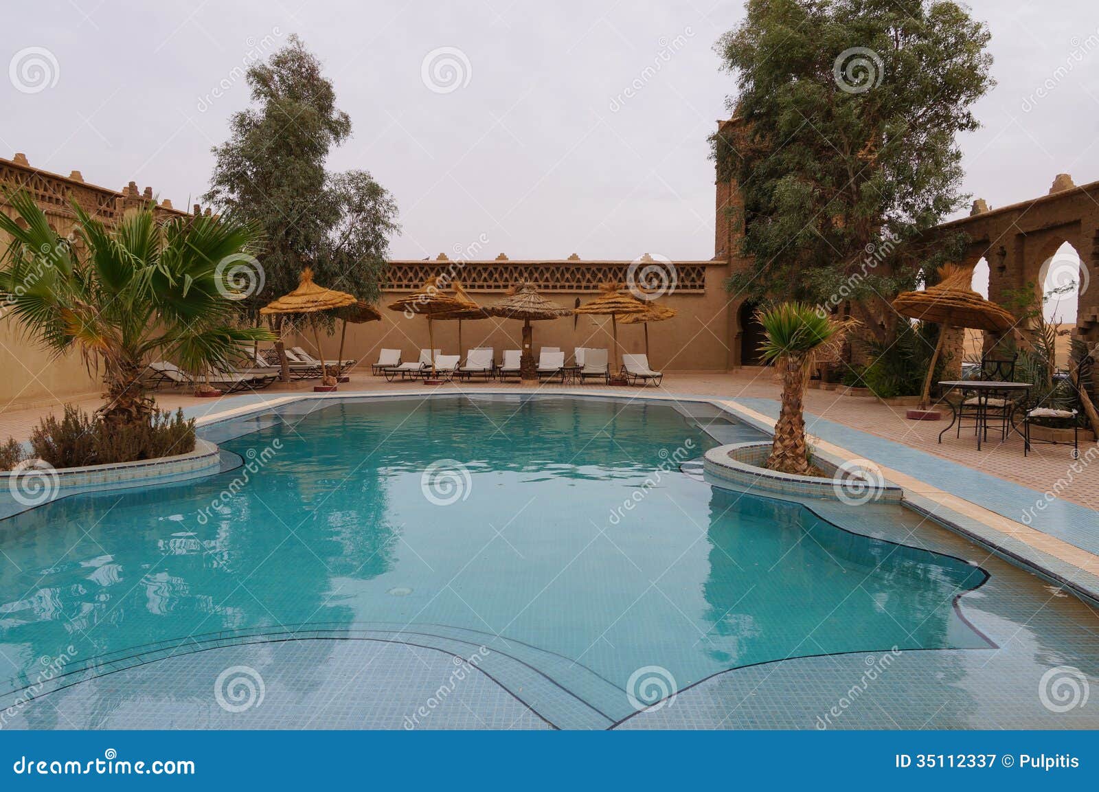 Grass Umbrellas and Sun Beds and Swimming Pool in Sahara Stock Image ...