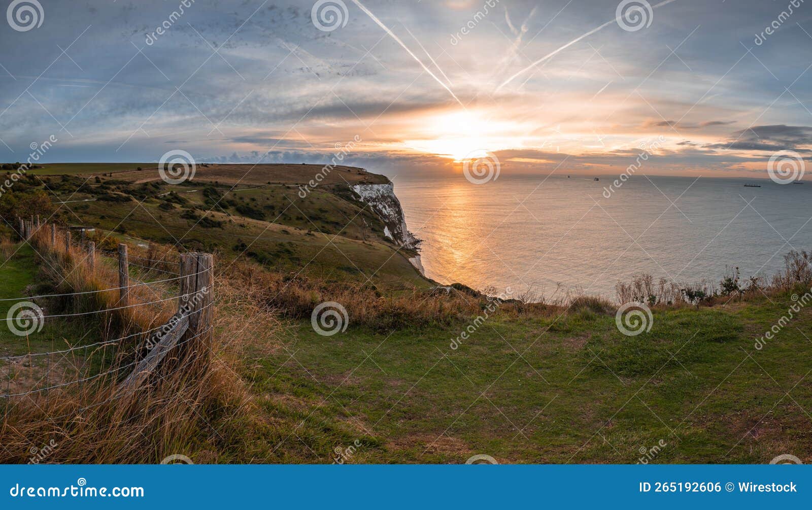 A Grassy Mountain Cliff, and the Reflection of the Sunlight on the Sea ...