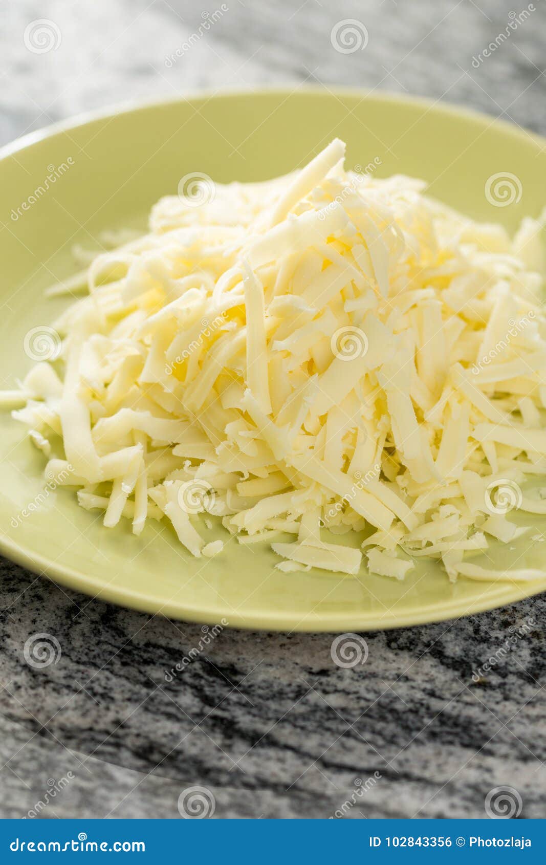 Grated Cheese Pile on the Plate Above Grey Granite Background Stock ...