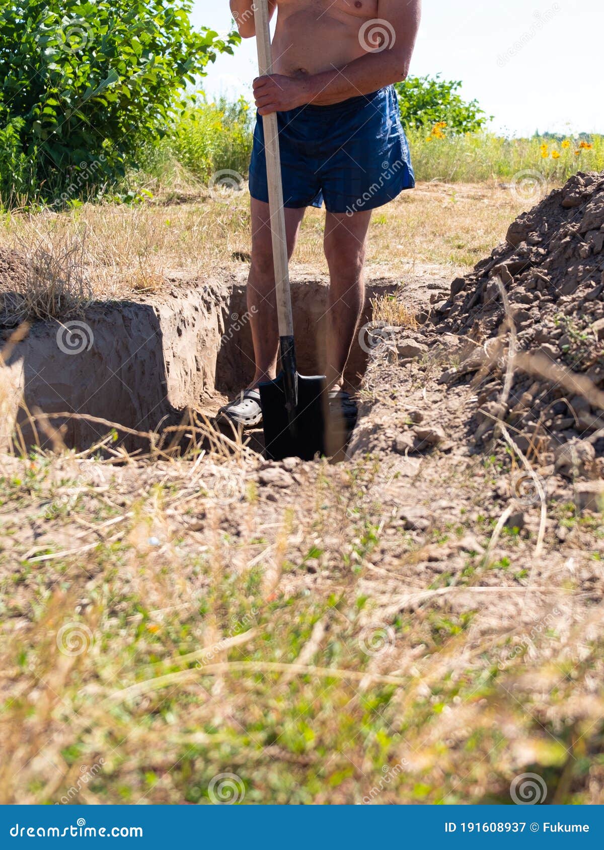 Gravedigger Digs a Grave. a Man Digs a Hole with a Shovel in a Cemetery ...