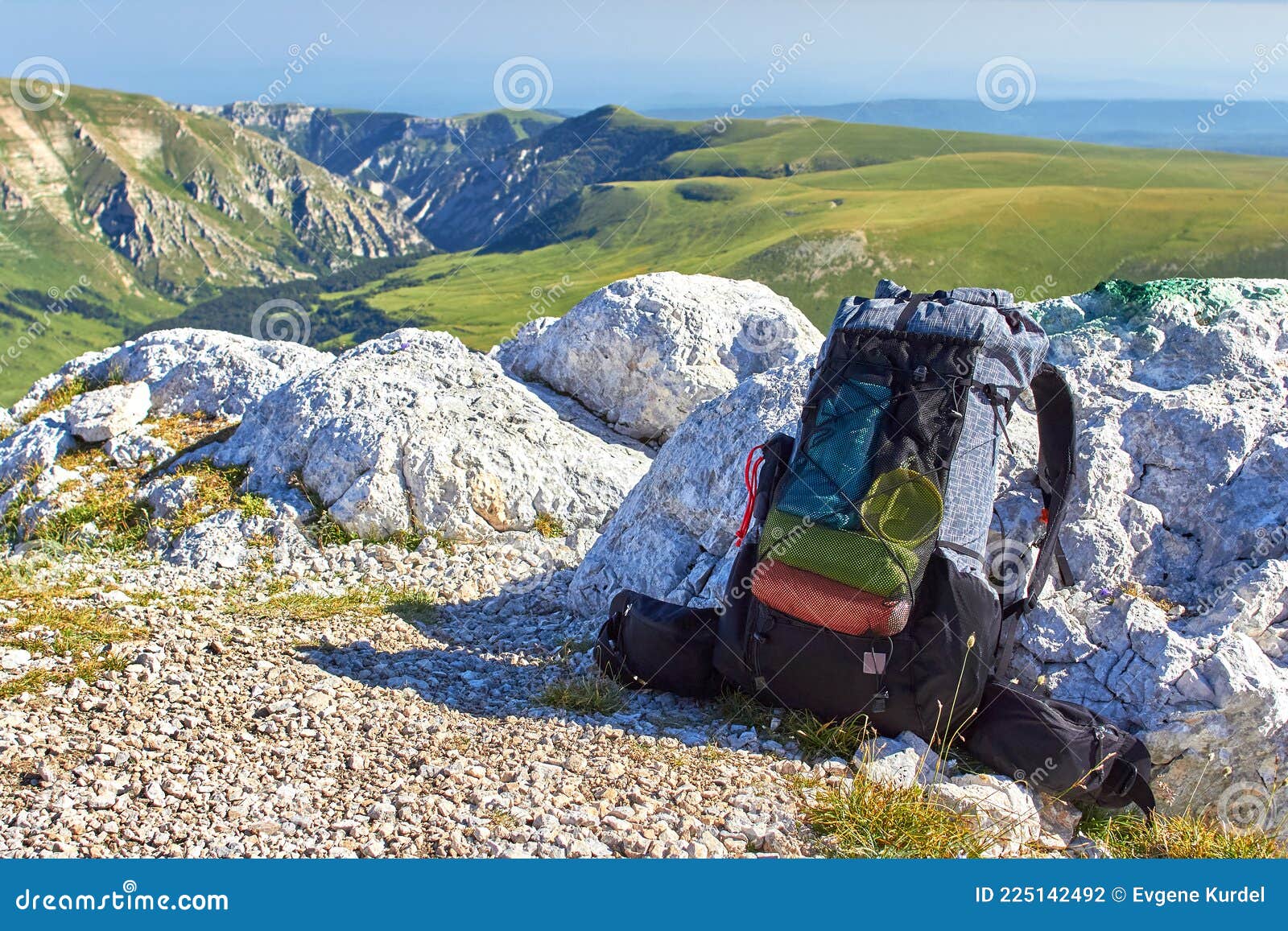 Gray Backpack on White Rocks in the Mountains Stock Photo - Image of ...