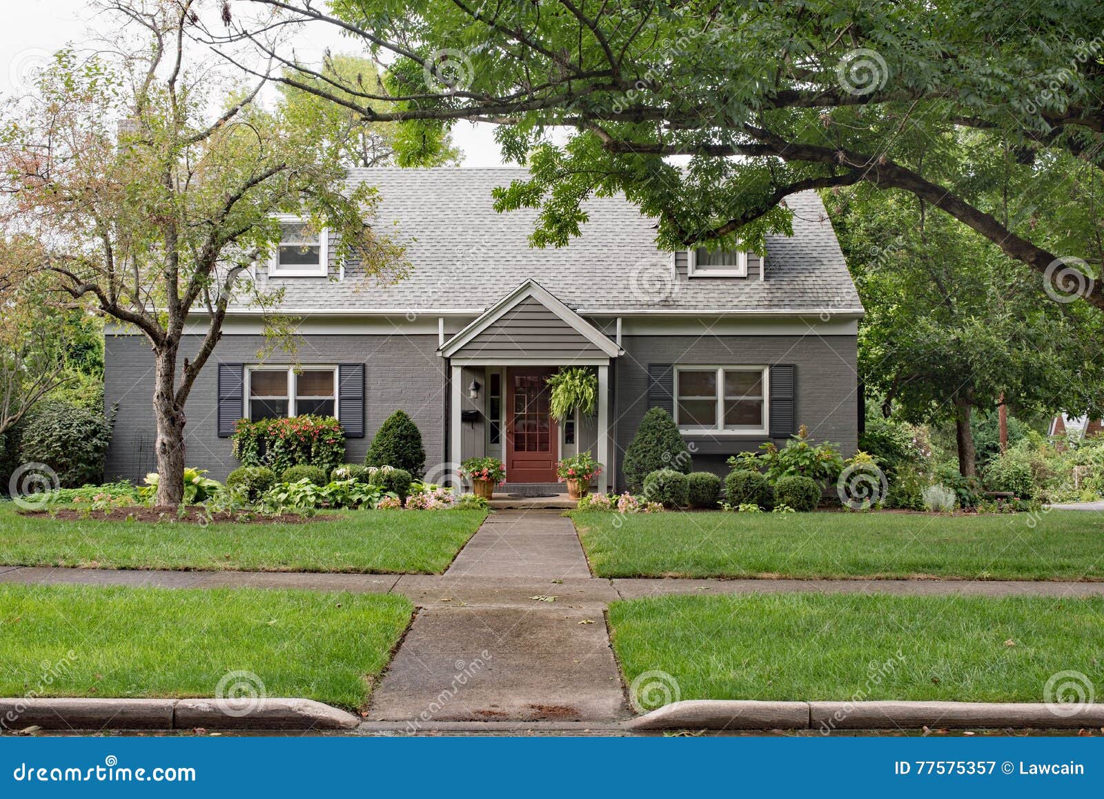 Gray Brick Cape Cod House on Overcast Day Stock Image - Image of hostas ...