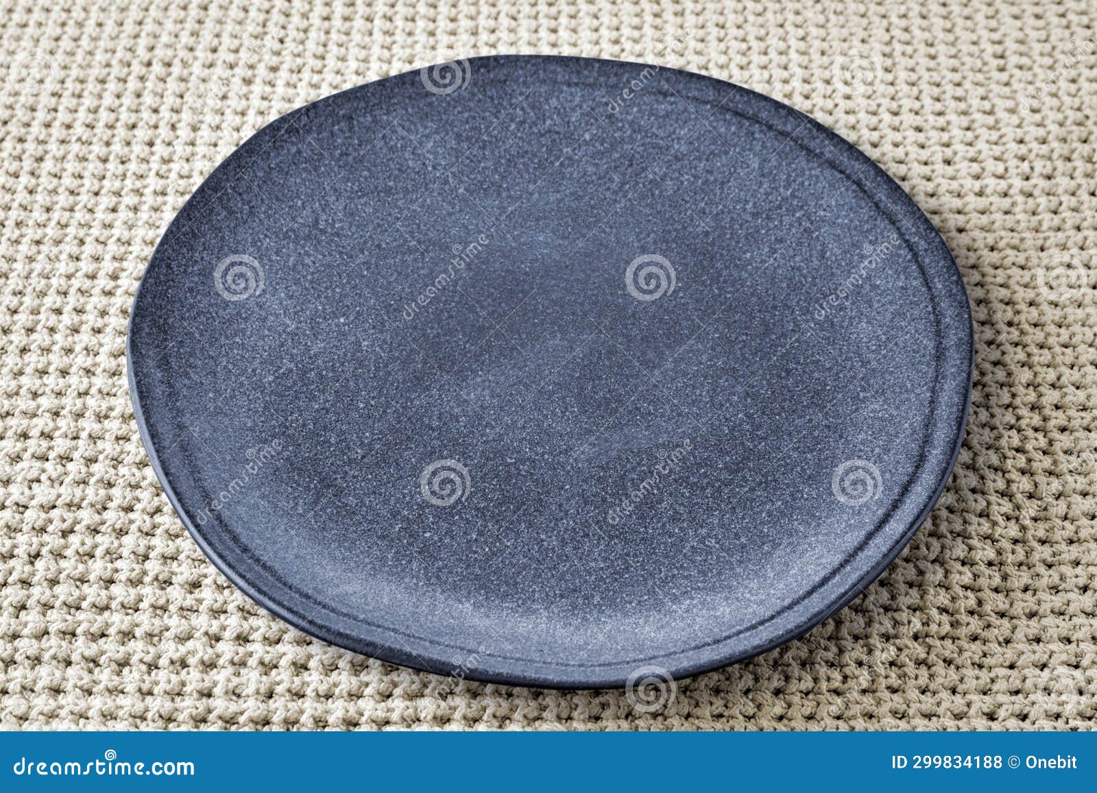 Gray Ceramic Plate of Irregular Shape on a Beige Knitted Background ...
