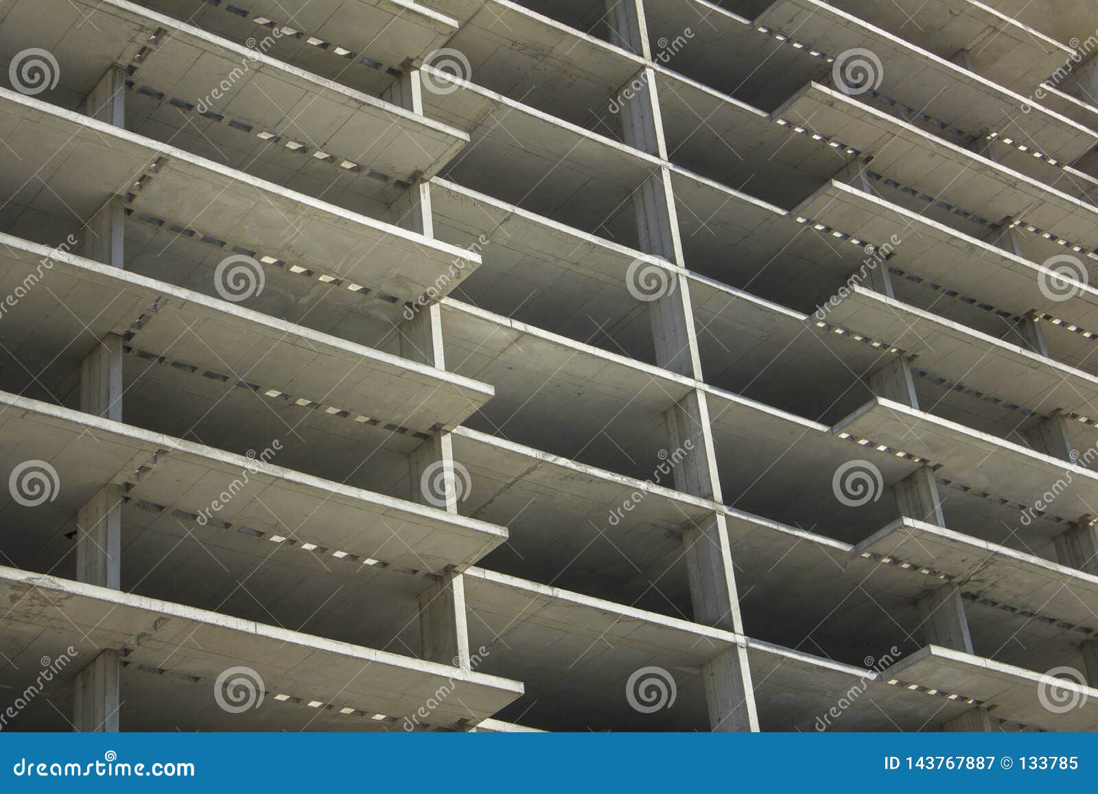 Gray Facade of a Concrete High-rise Unfinished Building. Intersecting ...