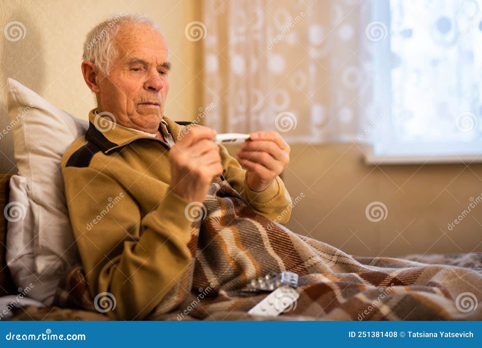 Gray Haired Elderly Man Looking at Body Temperature on Thermometer at ...