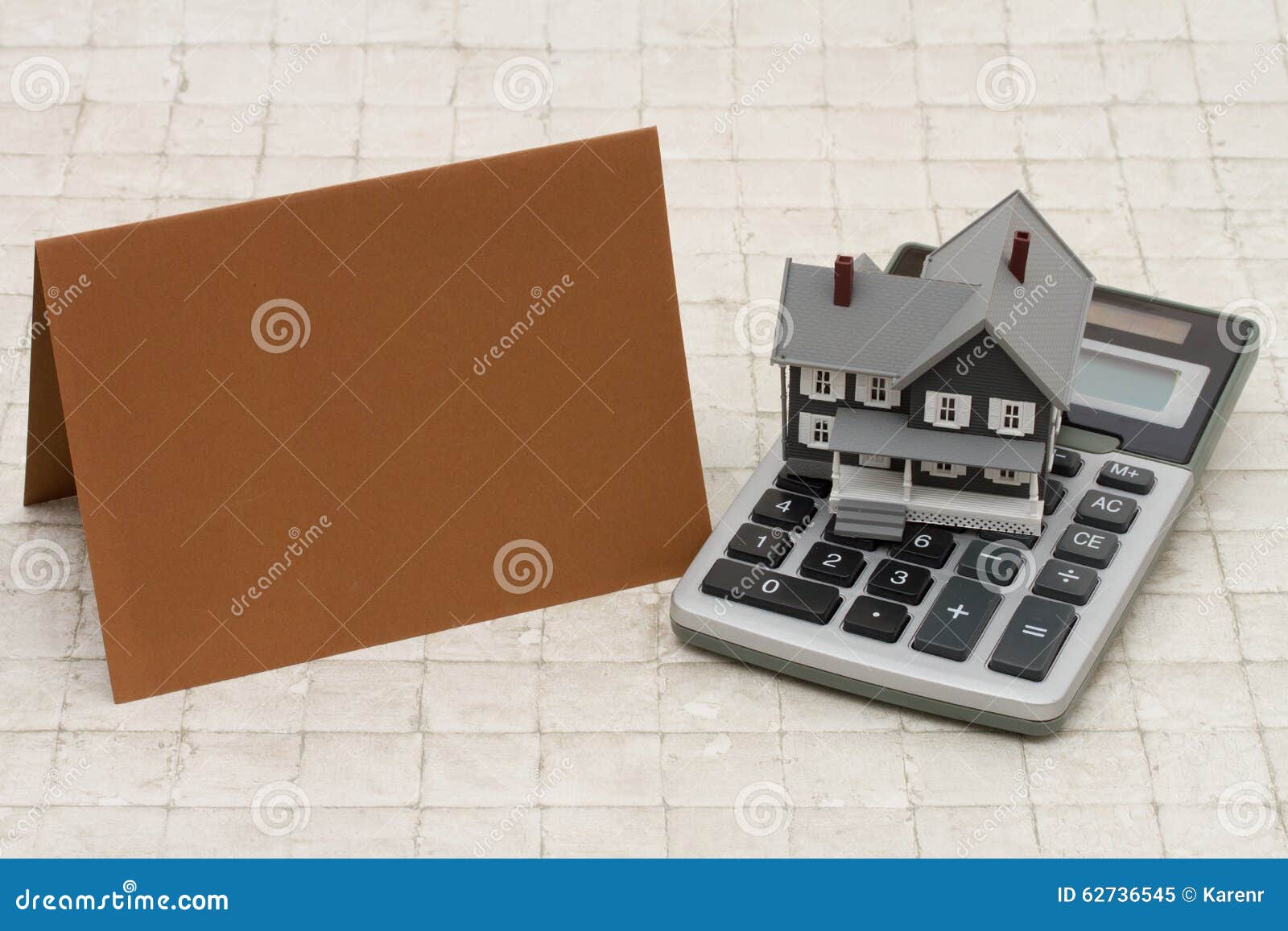 A Gray House, Brown Card And Calculator On Stone Background Stock Photo ...