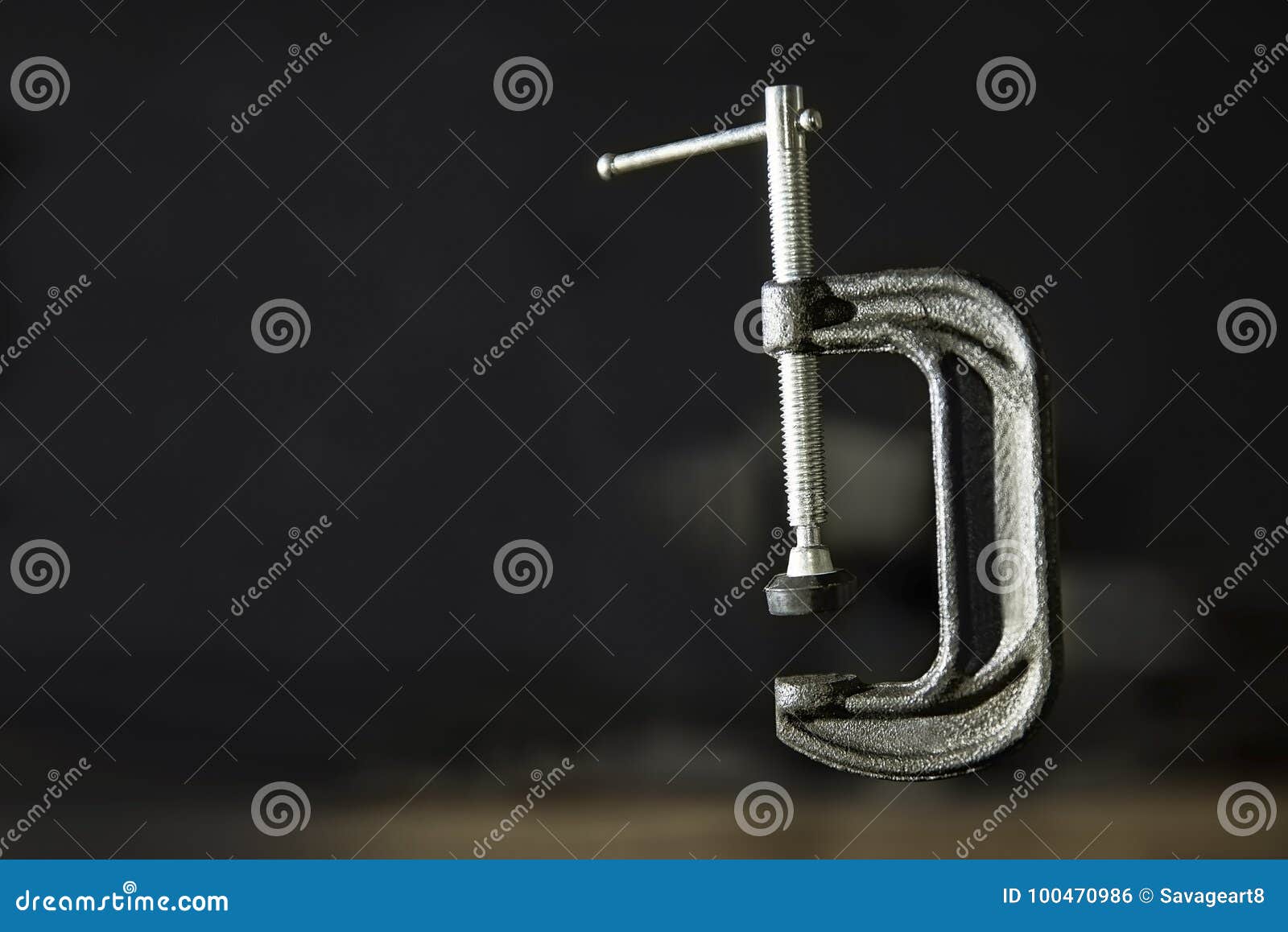A Gray Metal Clamp Against a Dark Background Stock Photo - Image of ...