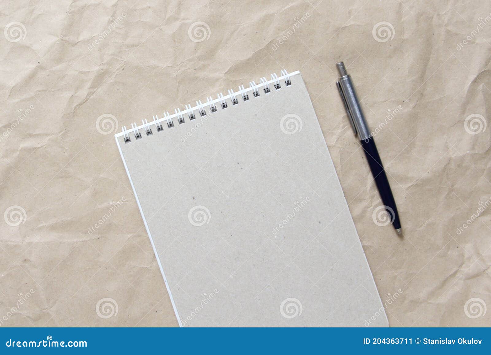 Gray Notepad with White Coiled Spring and Pen on a Background of Beige ...
