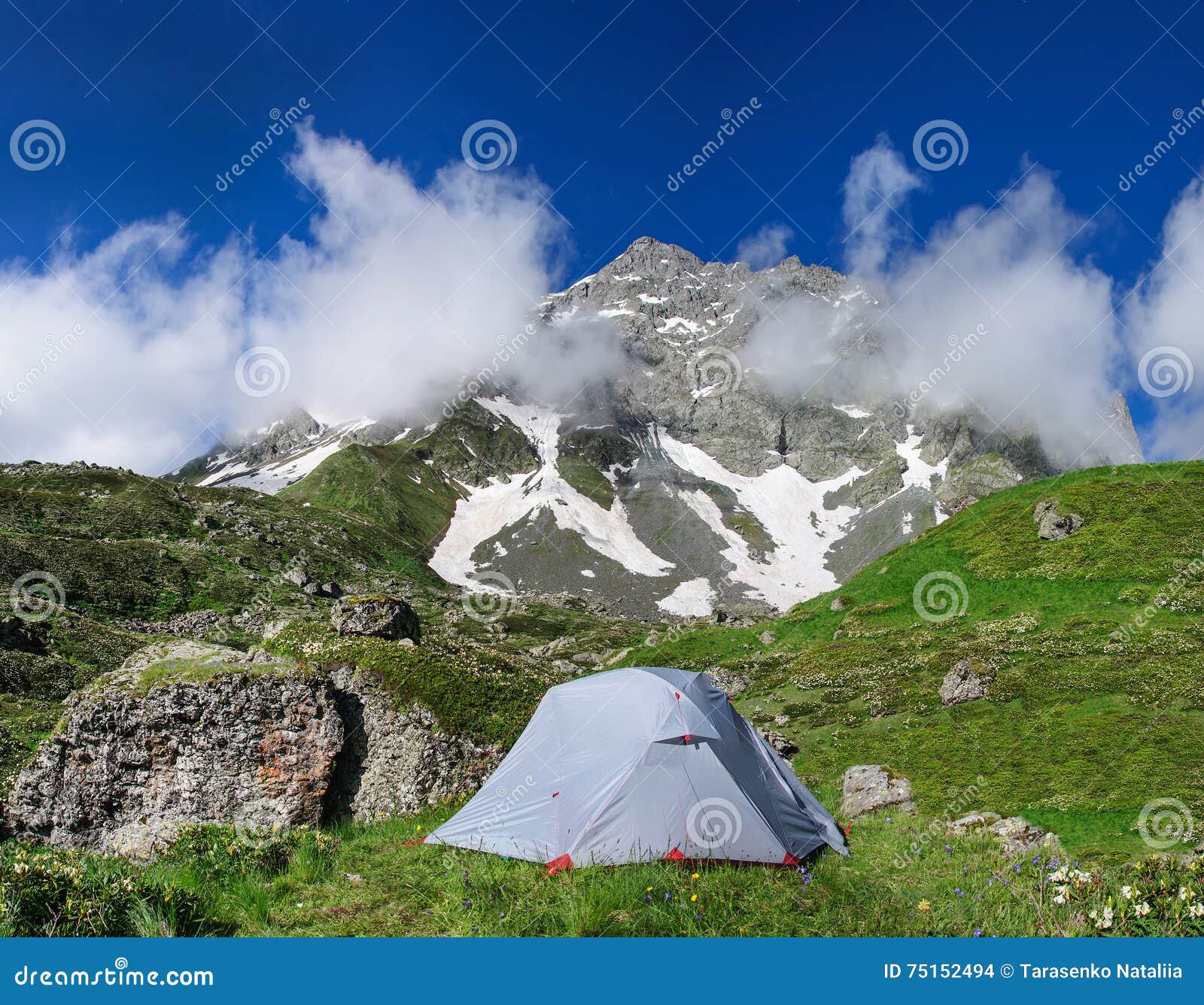 Gray Tent in Grass on Background of Mountains and Rocks Stock Photo ...