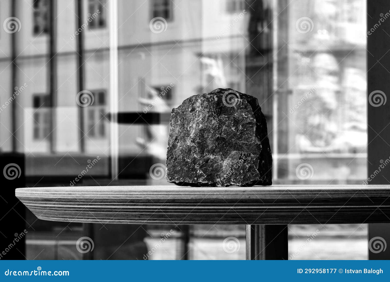 Gray Textured Split Face Granite Cube Displayed on Round Wood Table ...