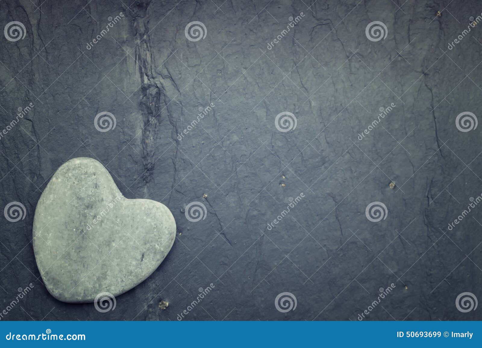 A Gray Zen Heart Shaped Rock in the Corner on a Tile Background Stock ...