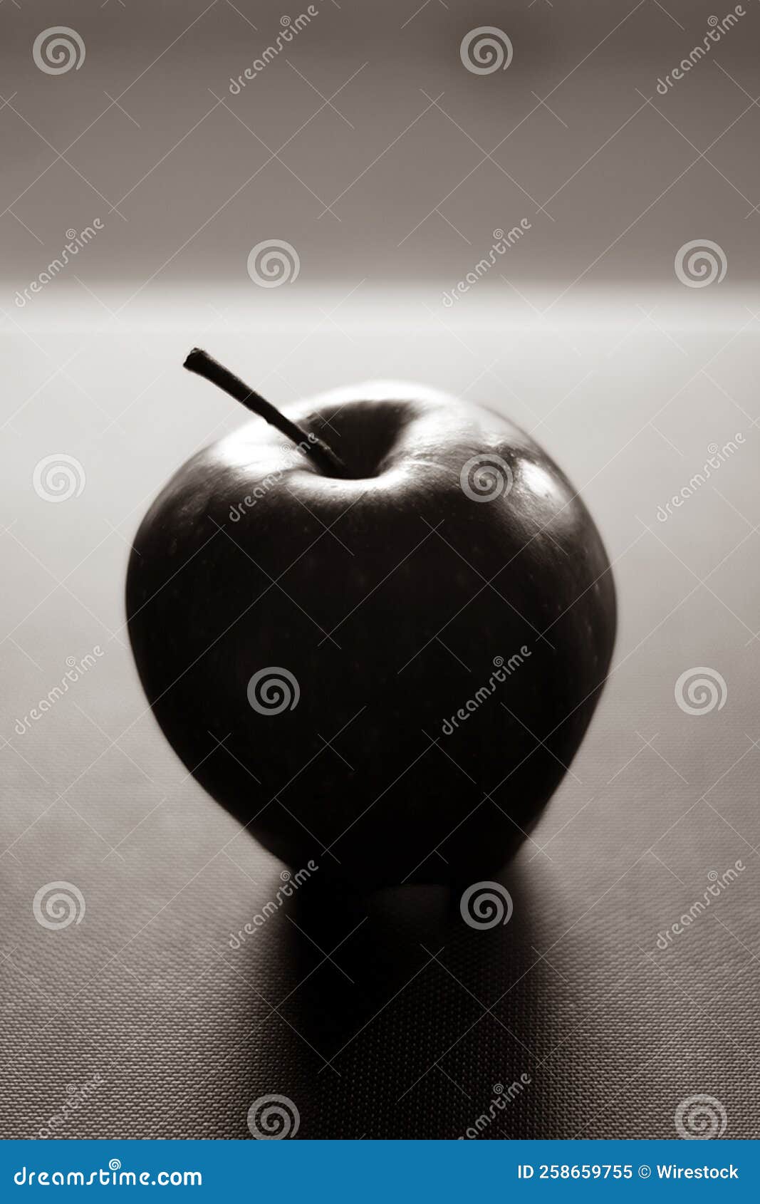 Grayscale of an Apple Shedding Its Shadow on a Table Stock Image ...