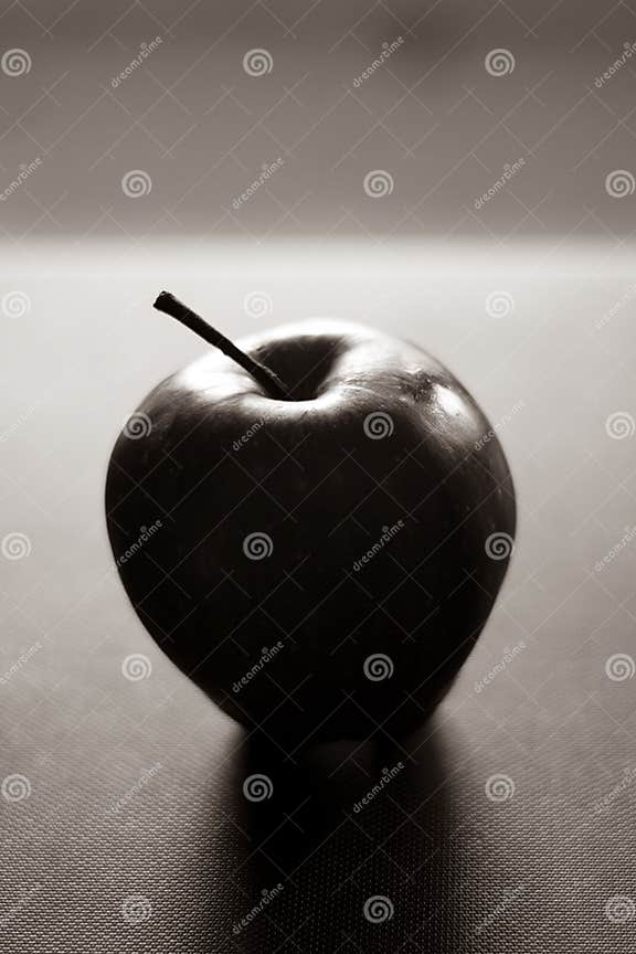 Grayscale of an Apple Shedding Its Shadow on a Table Stock Image ...