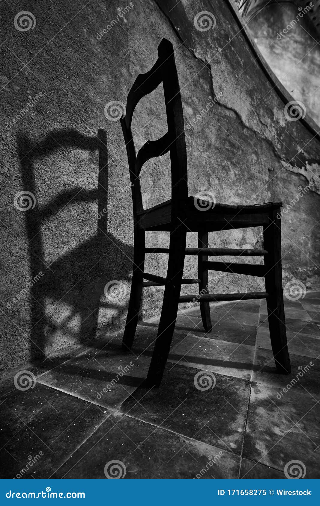 Grayscale Low-angle Shot of a Wooden Chair with a Shadow on the Wall ...