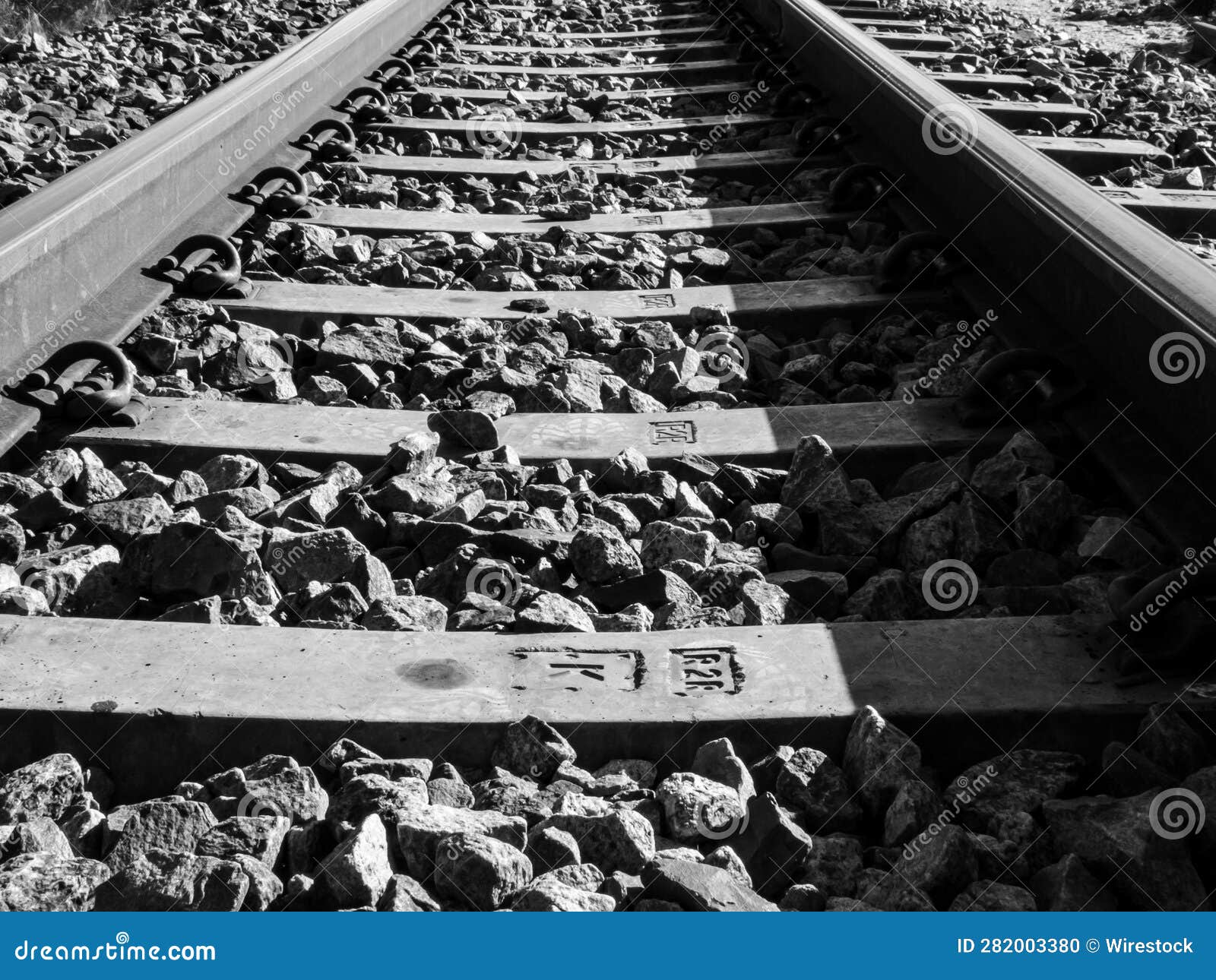 Grayscale of Old Railroad Tracks Covered with Pebbles Stock Photo ...