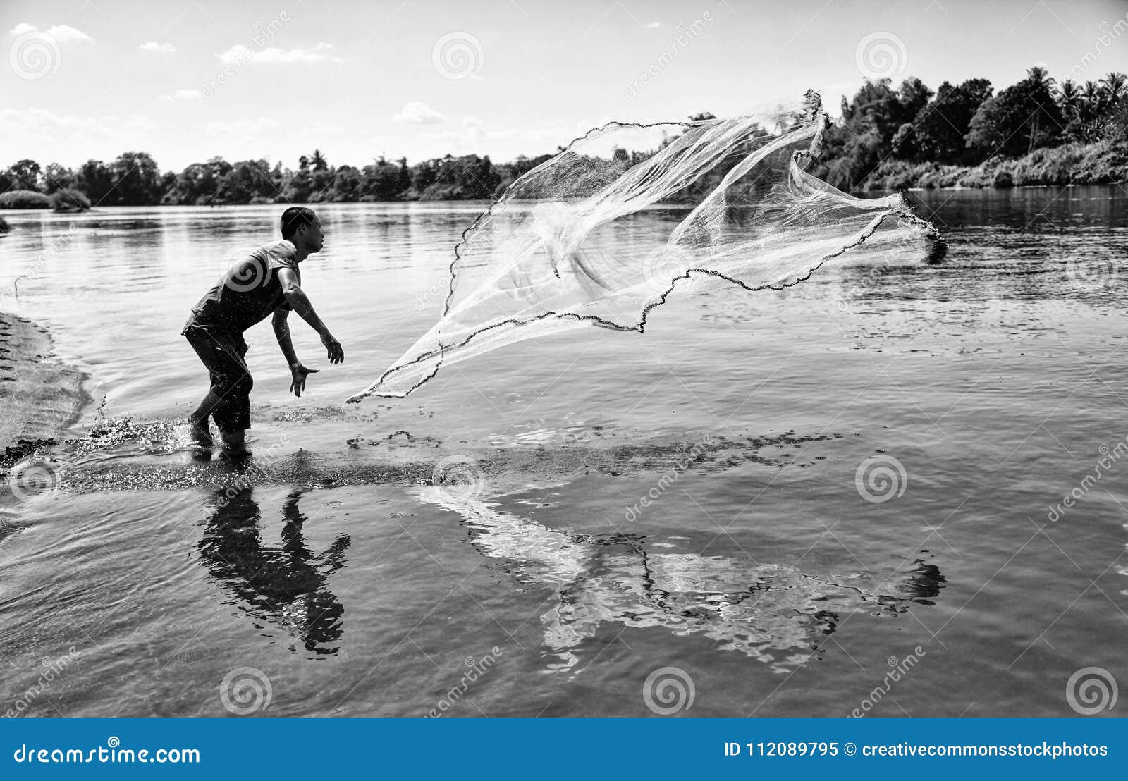 Grayscale Photo Of Man Throwing A Fishing Net Picture. Image: 112089795
