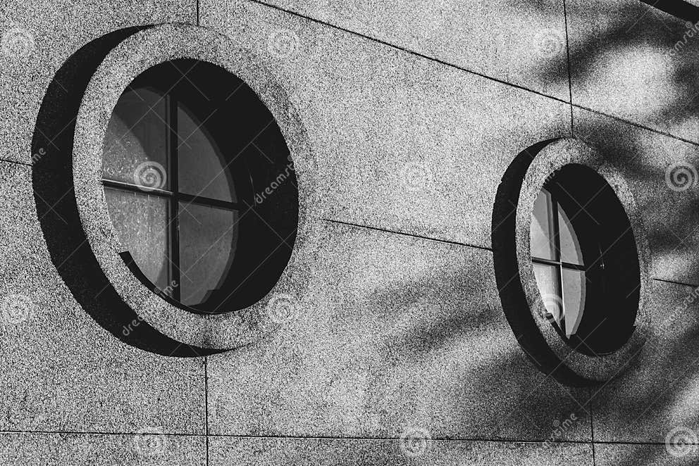 Grayscale of Round Modern Windows on a Stone Building Stock Image ...