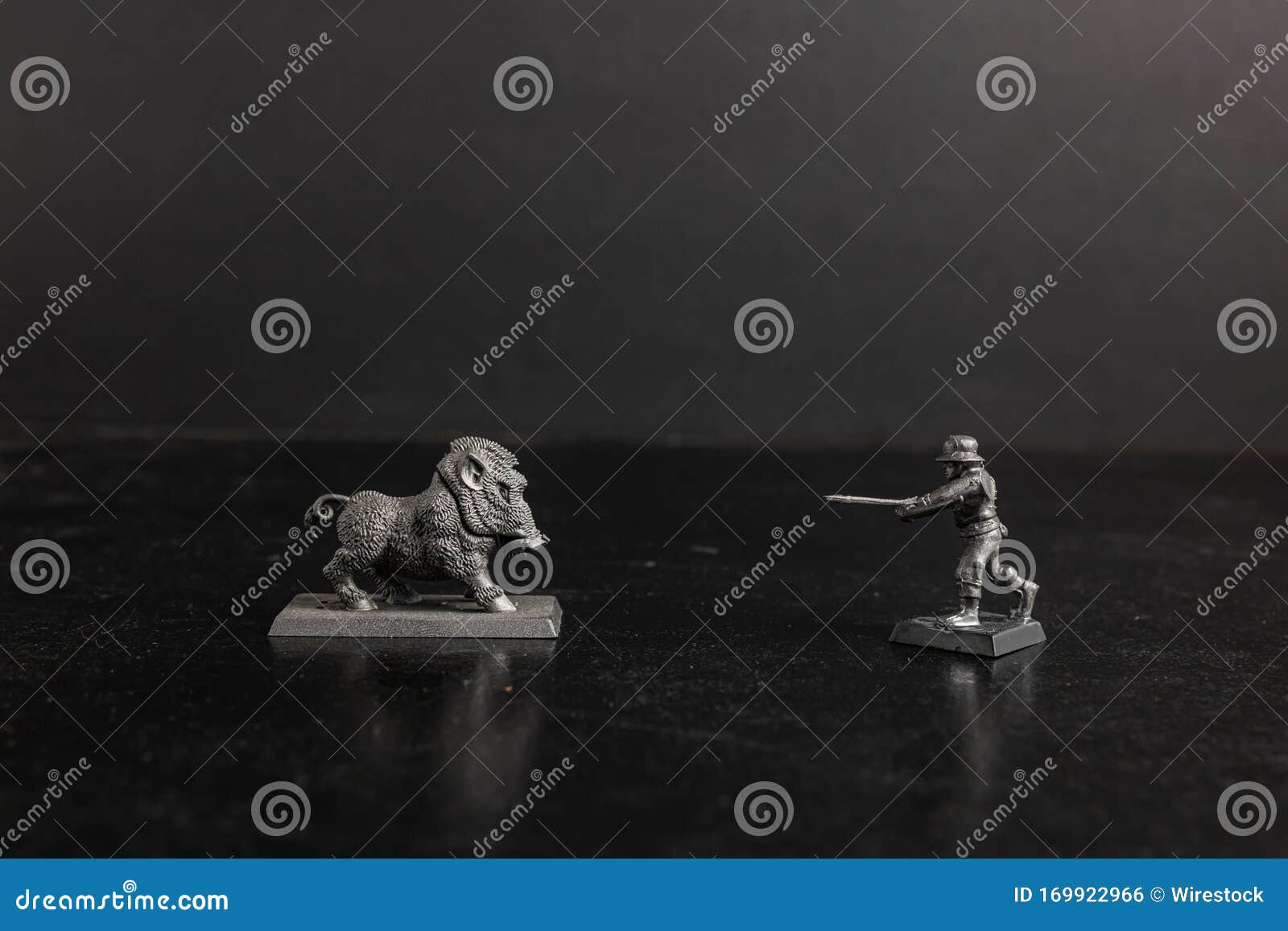Grayscale Selective Focus Shot of a Boar and a Hunter Figurines Stock ...