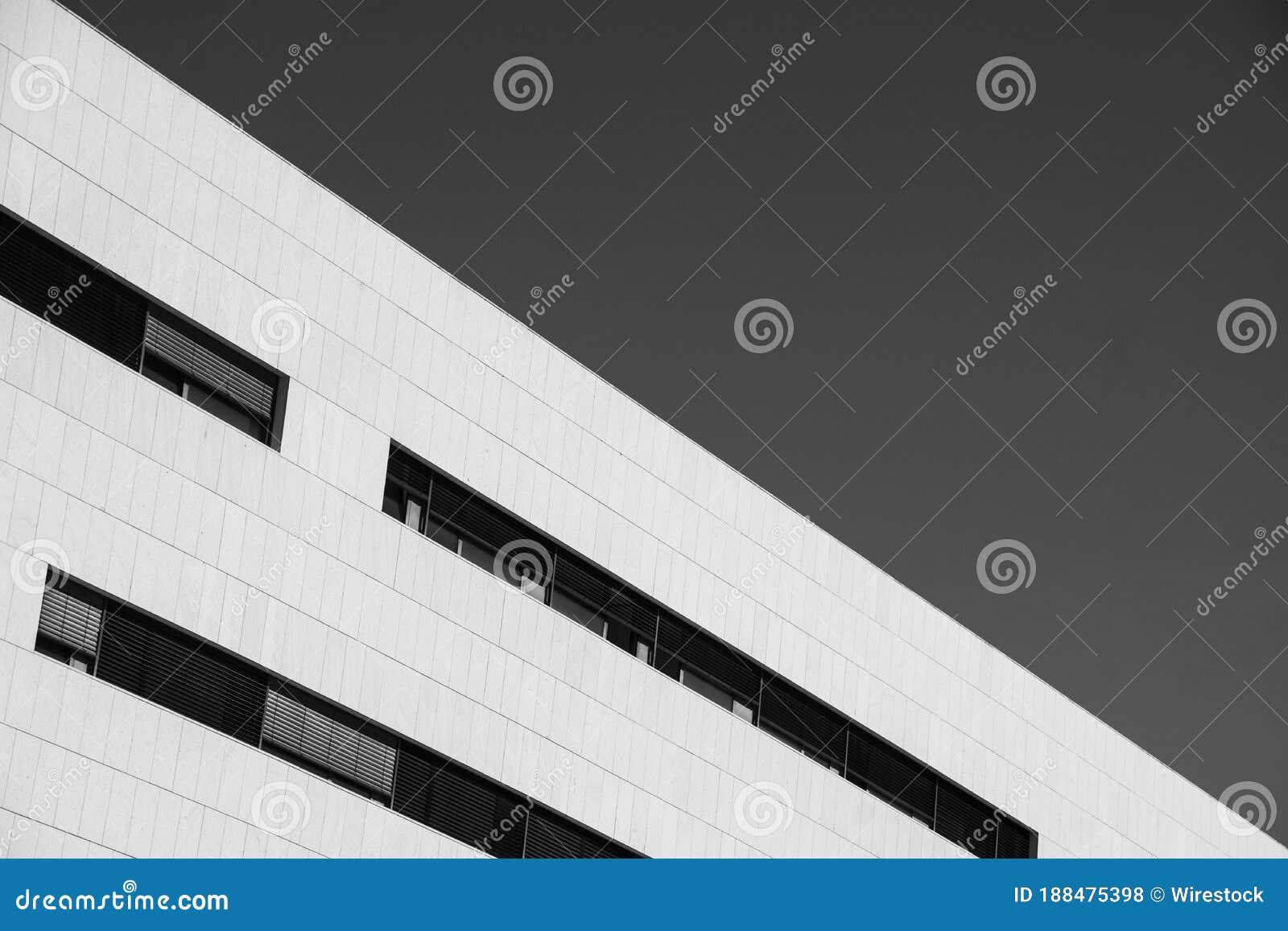 Grayscale Shot of an Abstract Building Facade on a Grey Sky Background ...