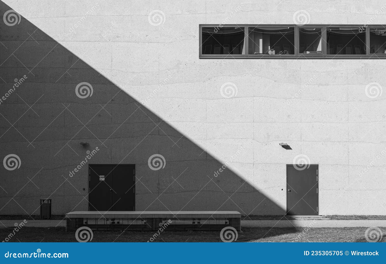Grayscale Shot of a Brick Building Facade with Doors Stock Image ...