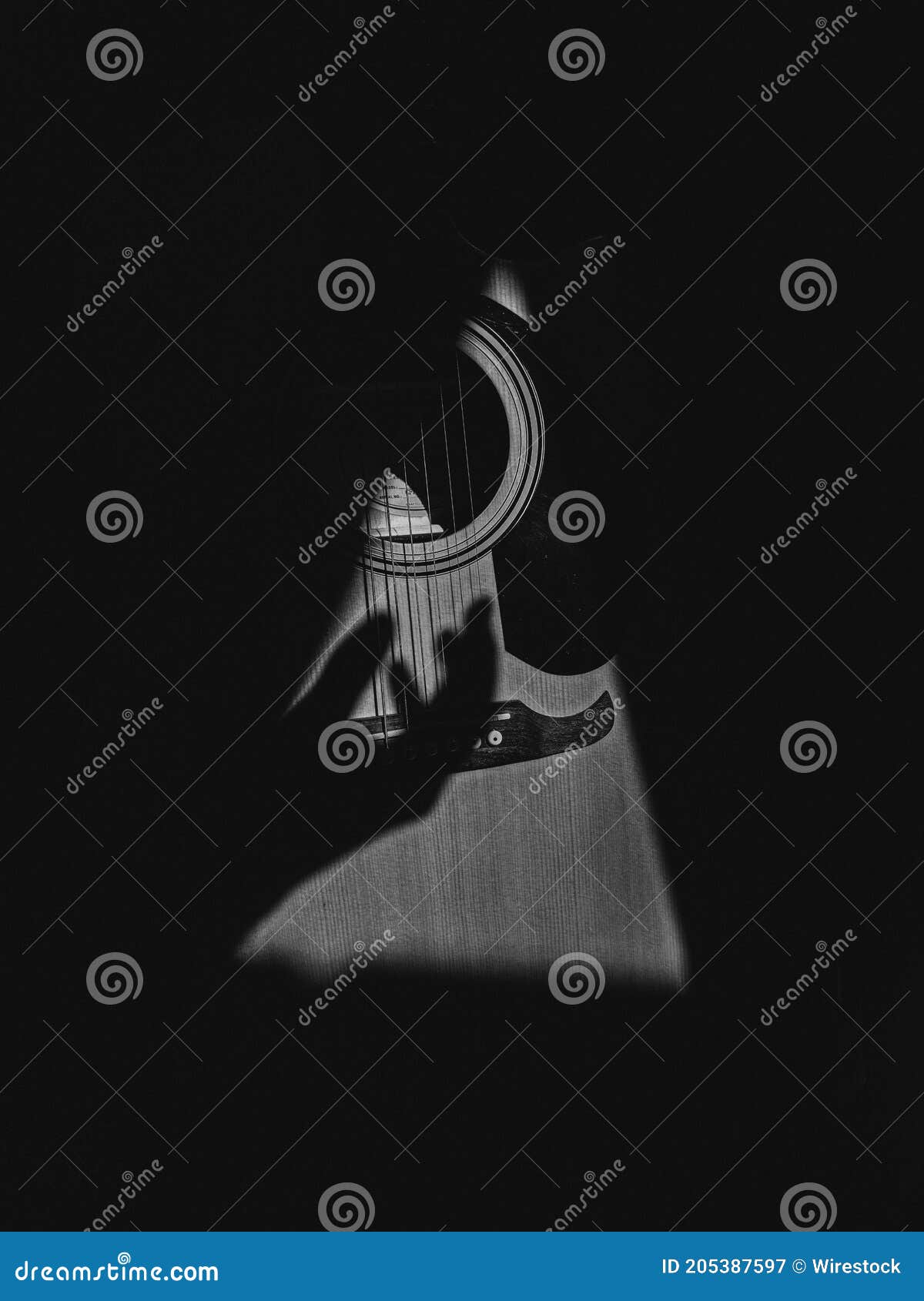 Grayscale Shot of a Hand Shadow Strumming on Guitar Strings Stock Image ...