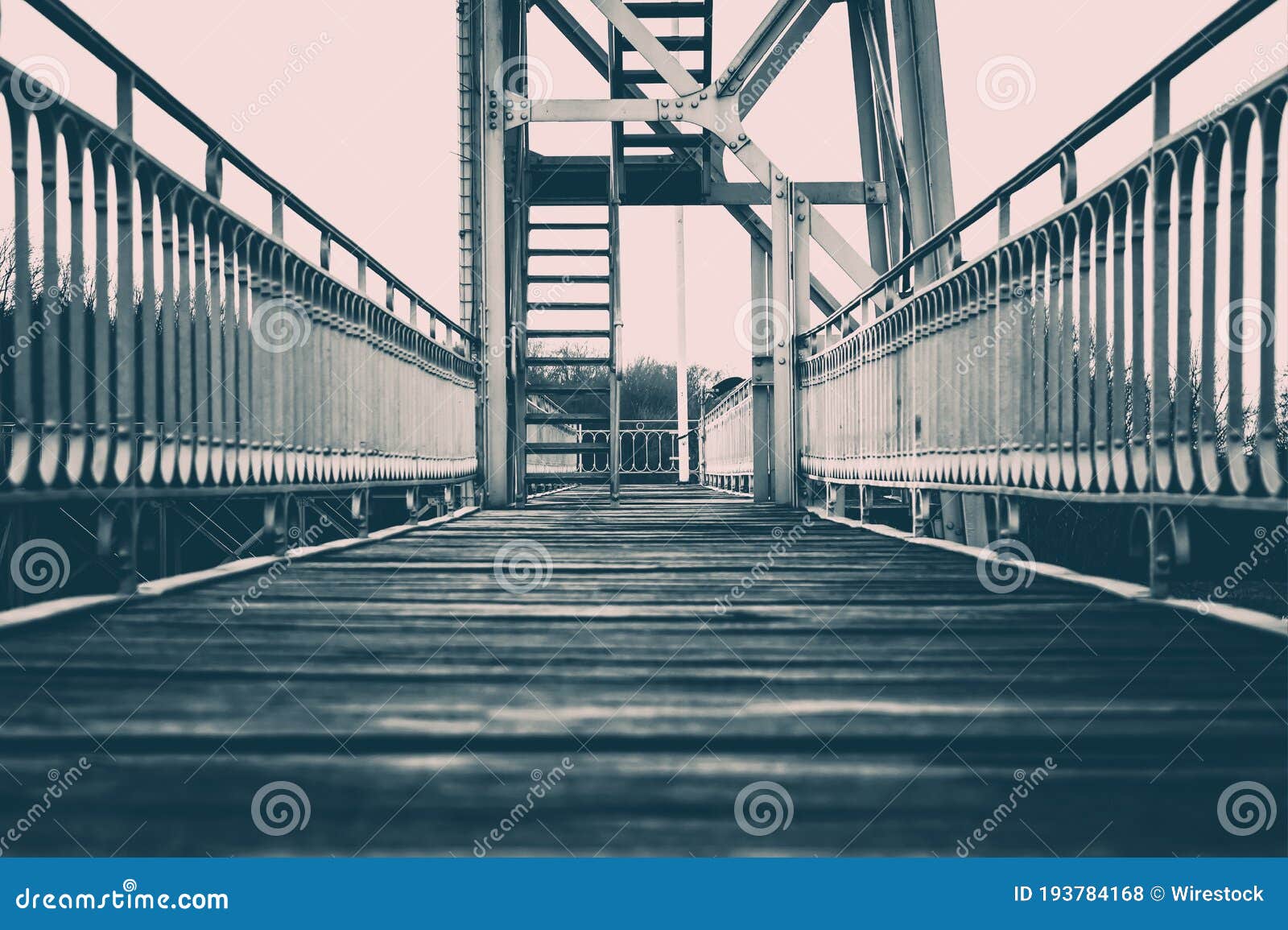Grayscale Shot of a Metal Footbridge on a White Sky Background Stock ...