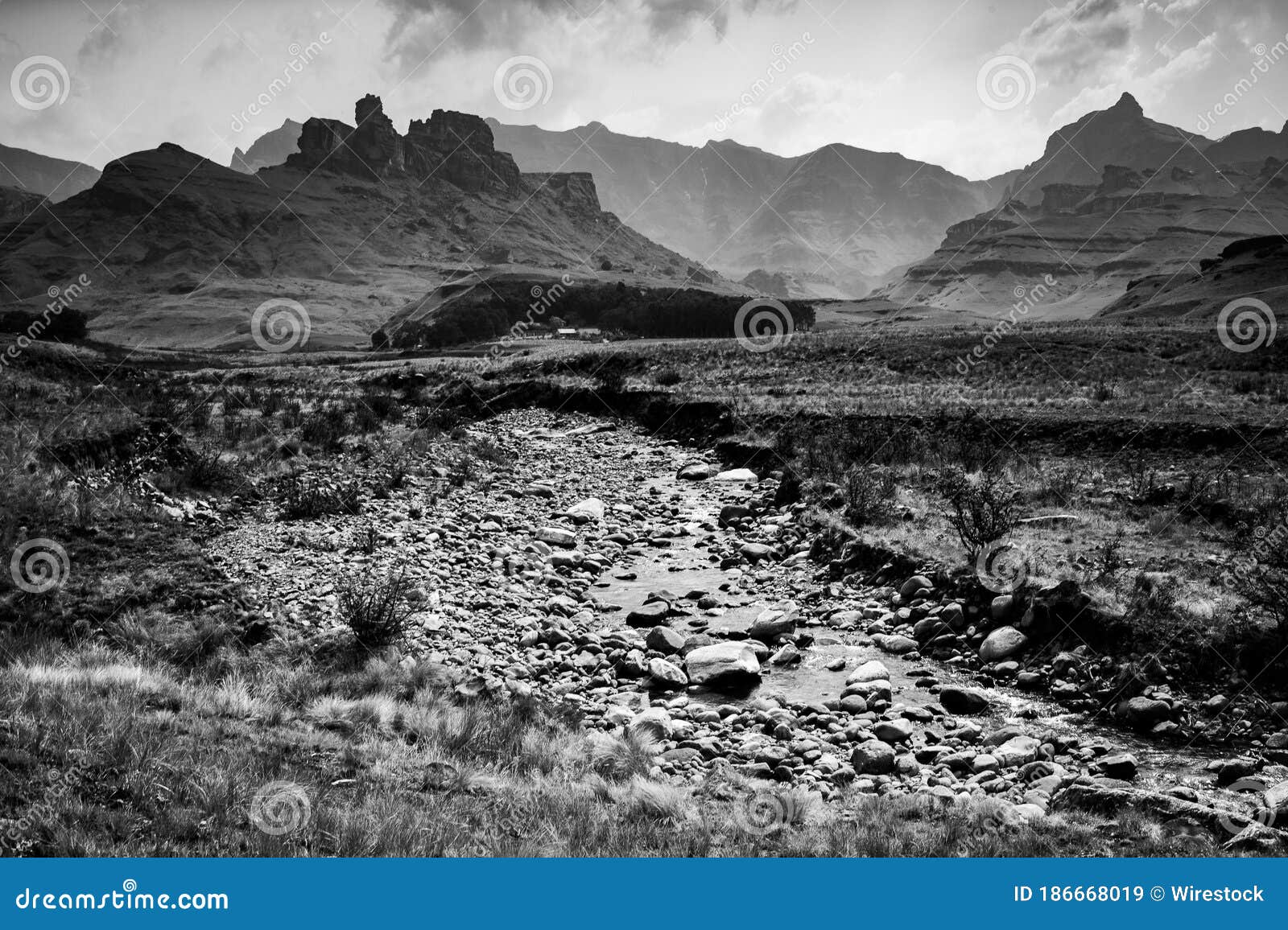 Grayscale Shot of a River with Tall Mountains in the Background Stock ...