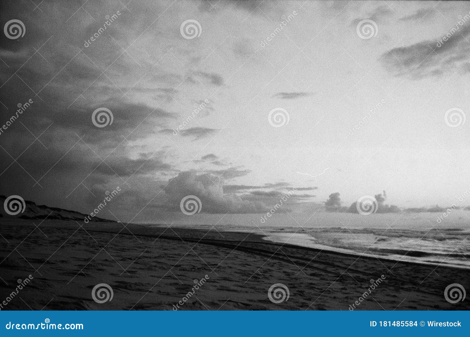 Grayscale Shot of Waves Crashing on Beach Under the Cloudy Sky Stock ...