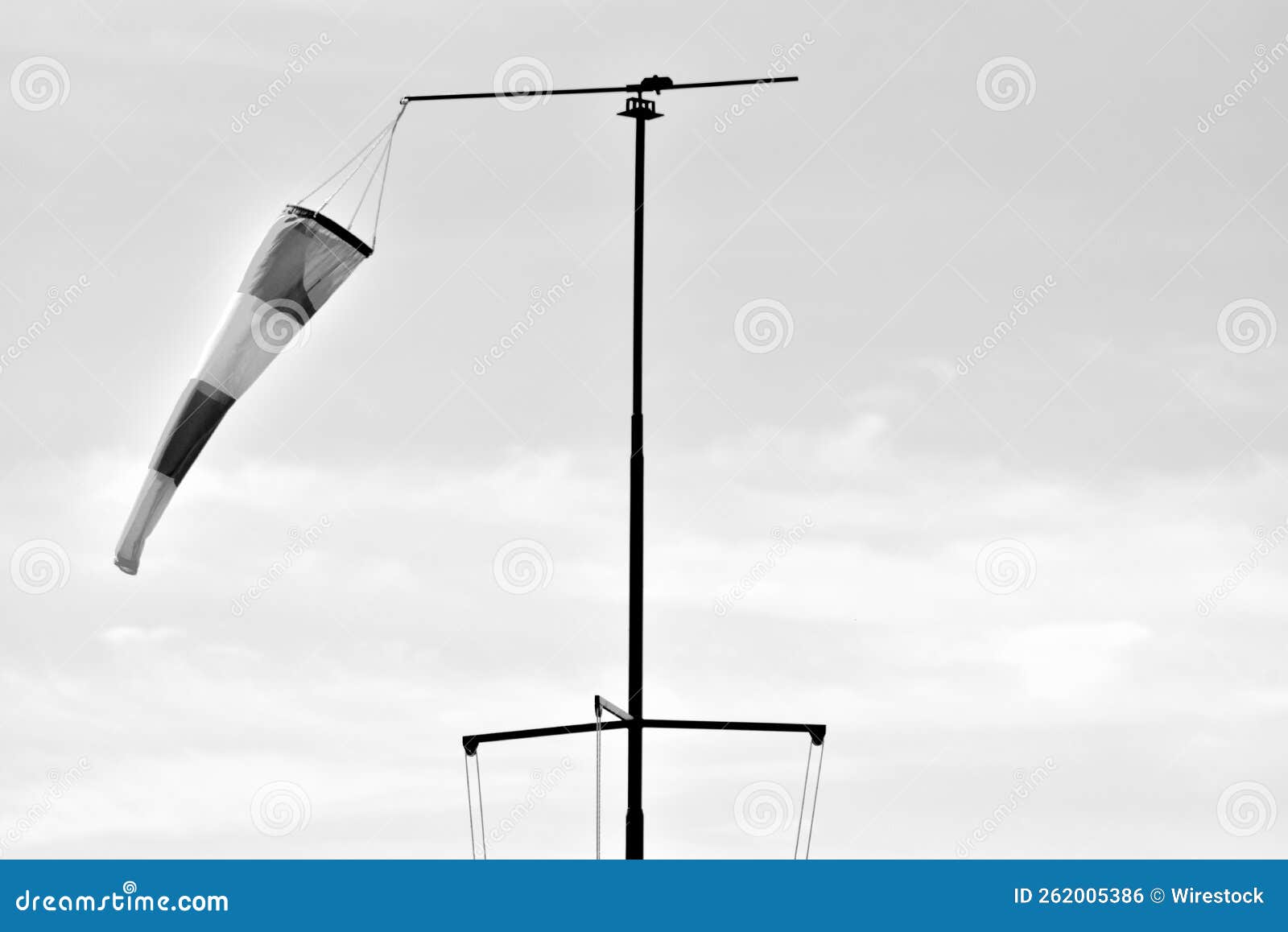 Grayscale Shot of a Windsock Hanging from a Metal Pole with a Light Sky ...