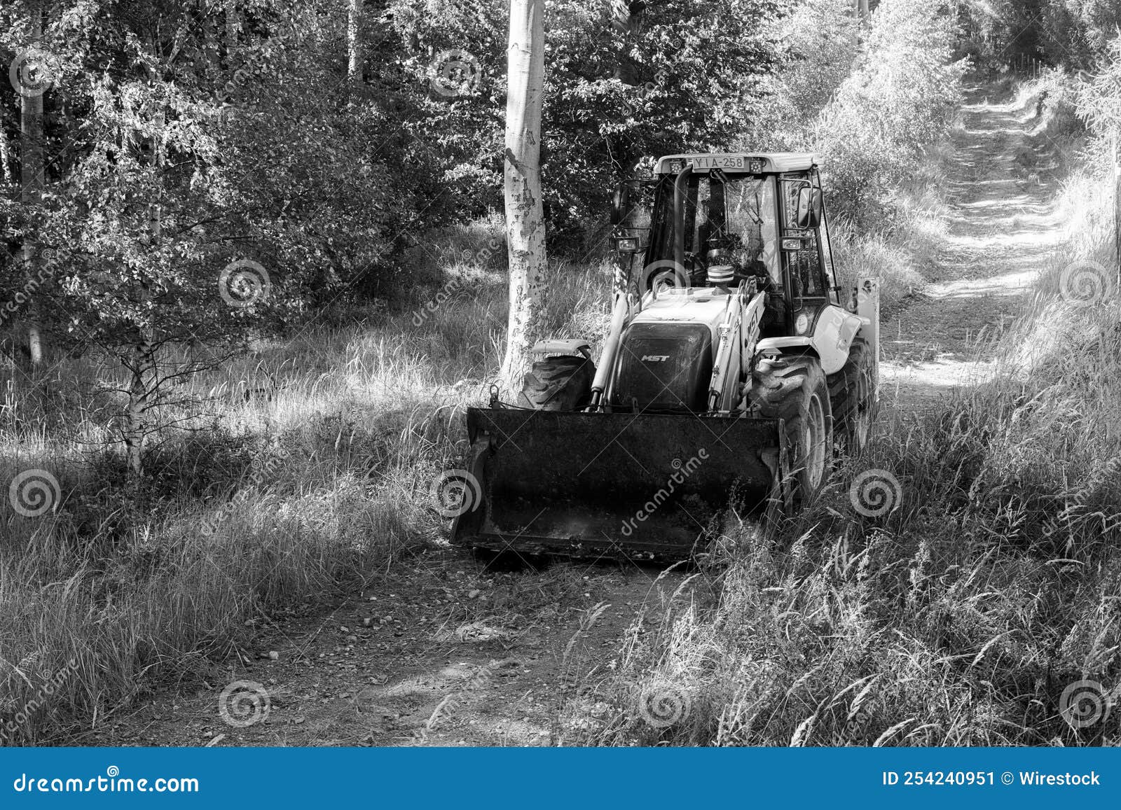 Grayscale of a Tractor Working in Shrubs and Plants in the Countryside ...