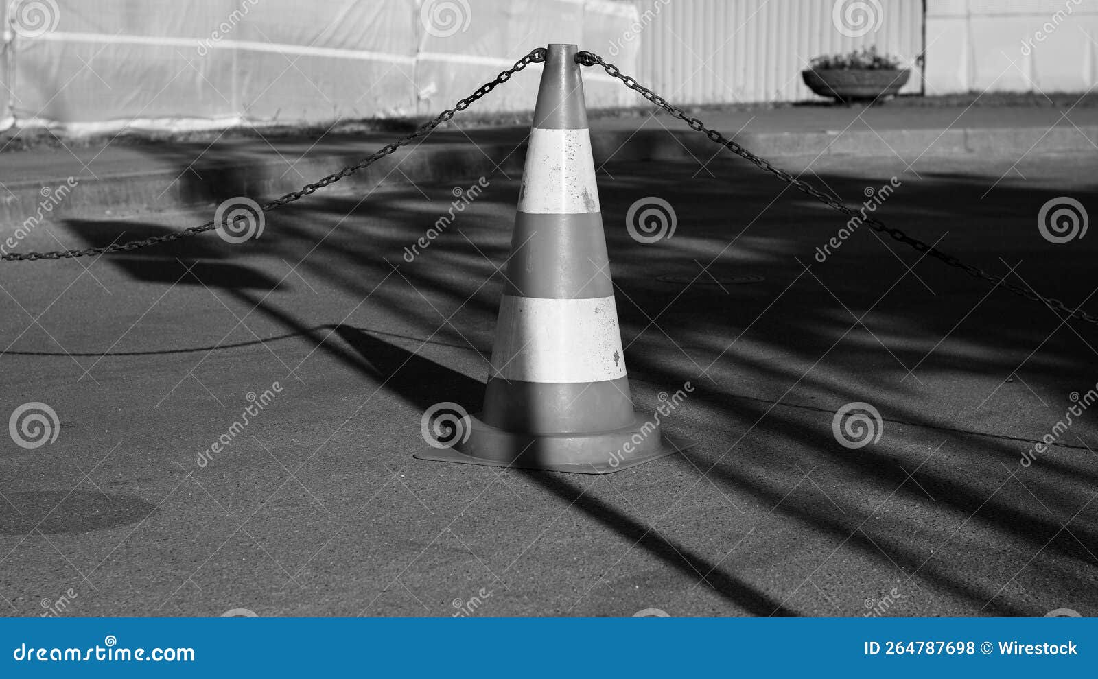 Grayscale of a Traffic Cone on the Asphalt with Chains on Both Sides ...