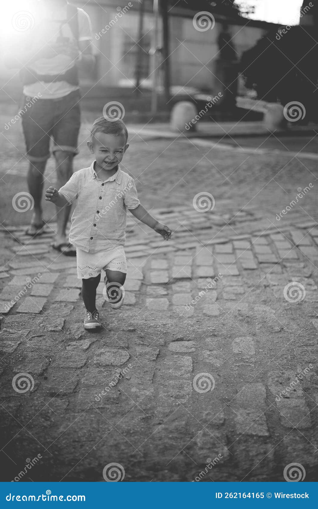 Grayscale Vertical Picture of a Running Happy Caucasian Kid Stock Image ...