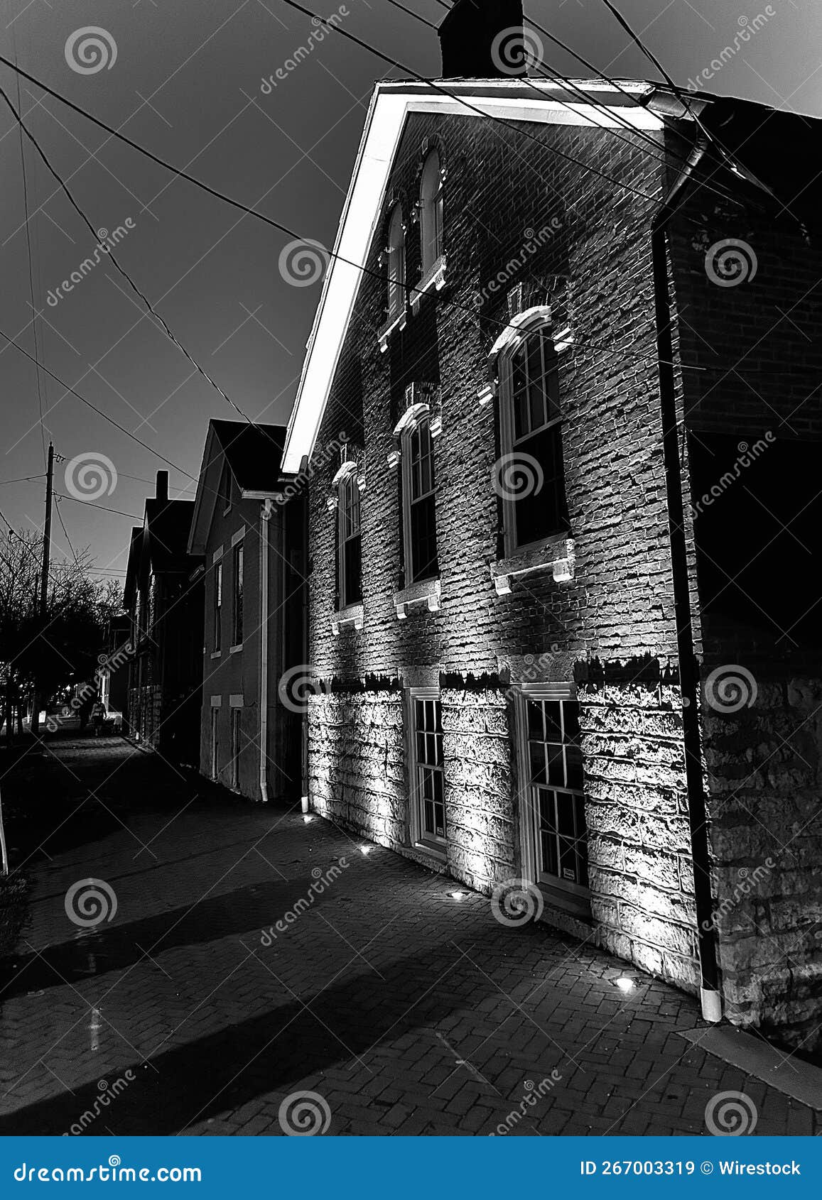 Grayscale Vertical Shot of Buildings Row in Small Street Stock Image ...