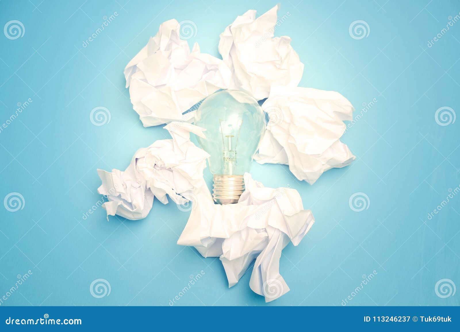 Great Concept with Crumpled Office Paper and Light Bulb on a Blue ...