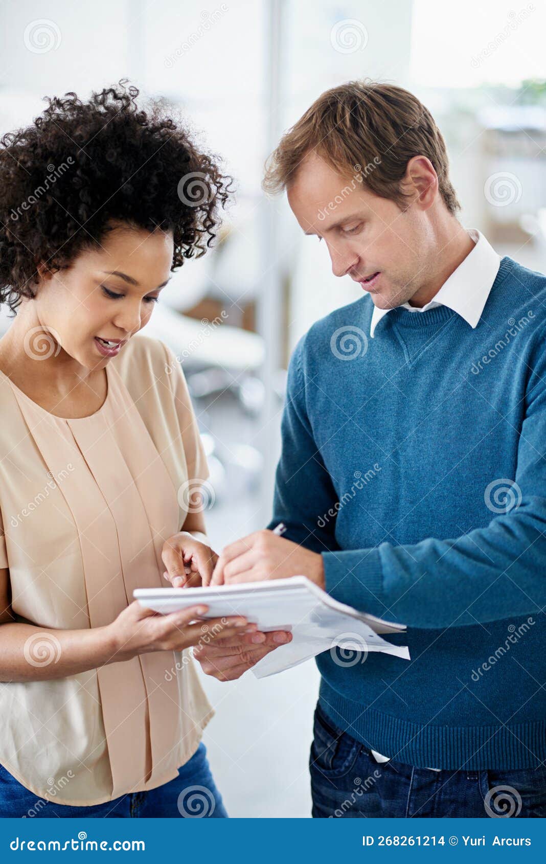 Great Minds Think Alike. Two Colleagues Discussing Ideas on a Notepad ...