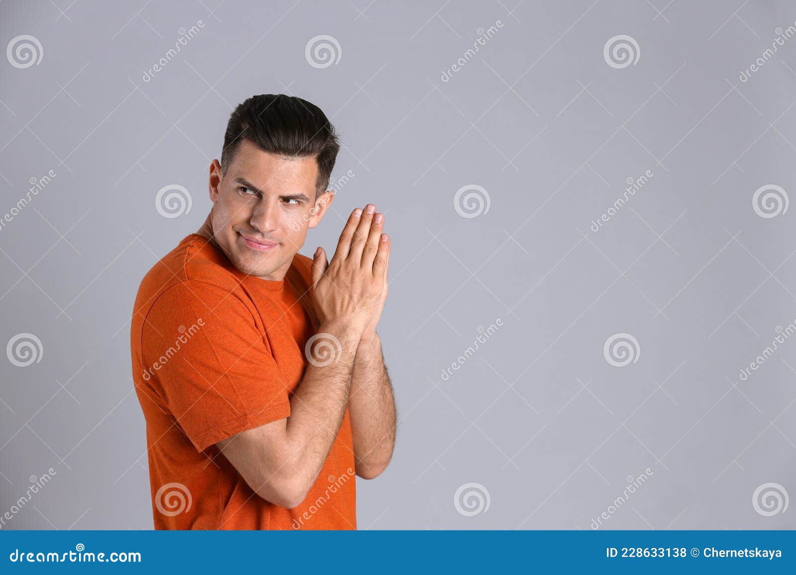 Greedy Man Rubbing Hands on Grey Background, Space for Text Stock Photo ...