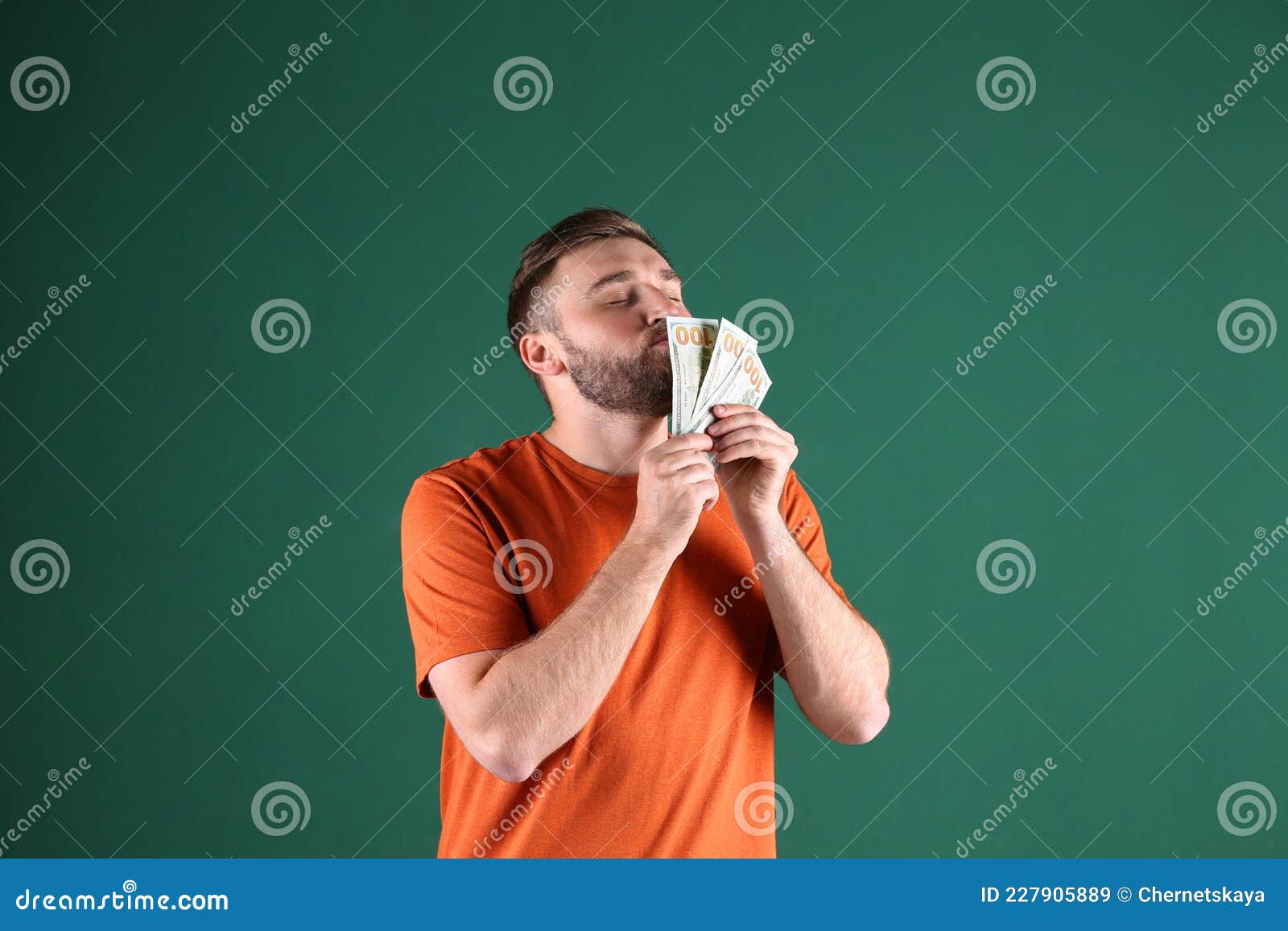 Greedy Young Man Sniffing Money on Green Background Stock Image - Image ...