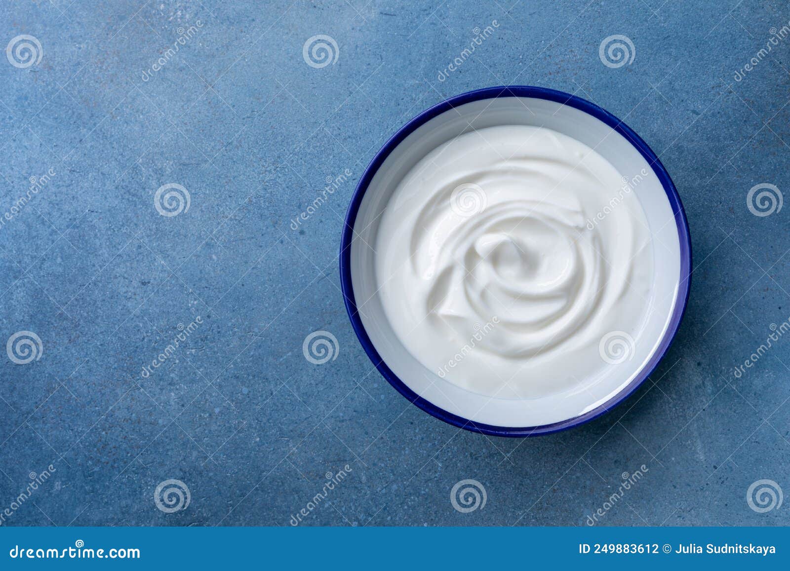 Greek Yogurt in Bowl on Blue Stone Table Top View Stock Photo - Image ...