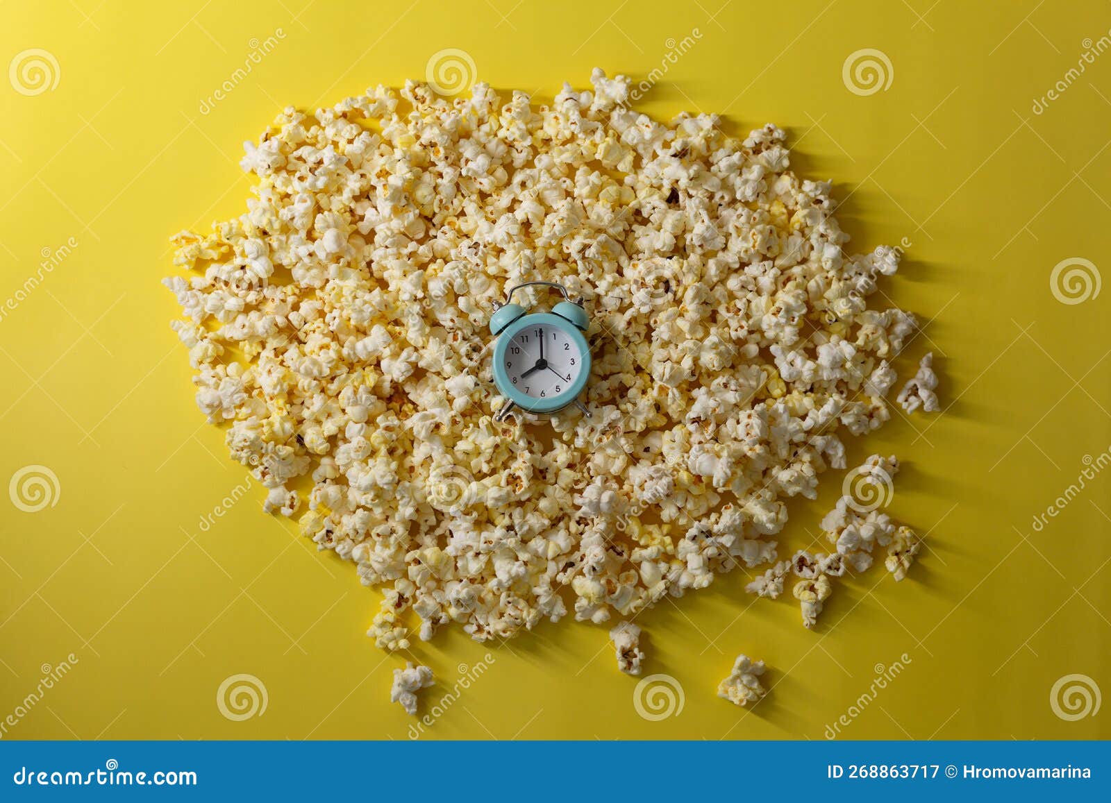 A Green Alarm Clock Lies in Clouds of Popcorn. Stock Image - Image of ...