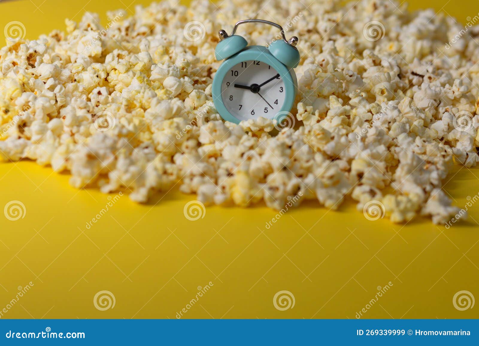A Green Alarm Clock Lies in Clouds of Popcorn Stock Image - Image of ...