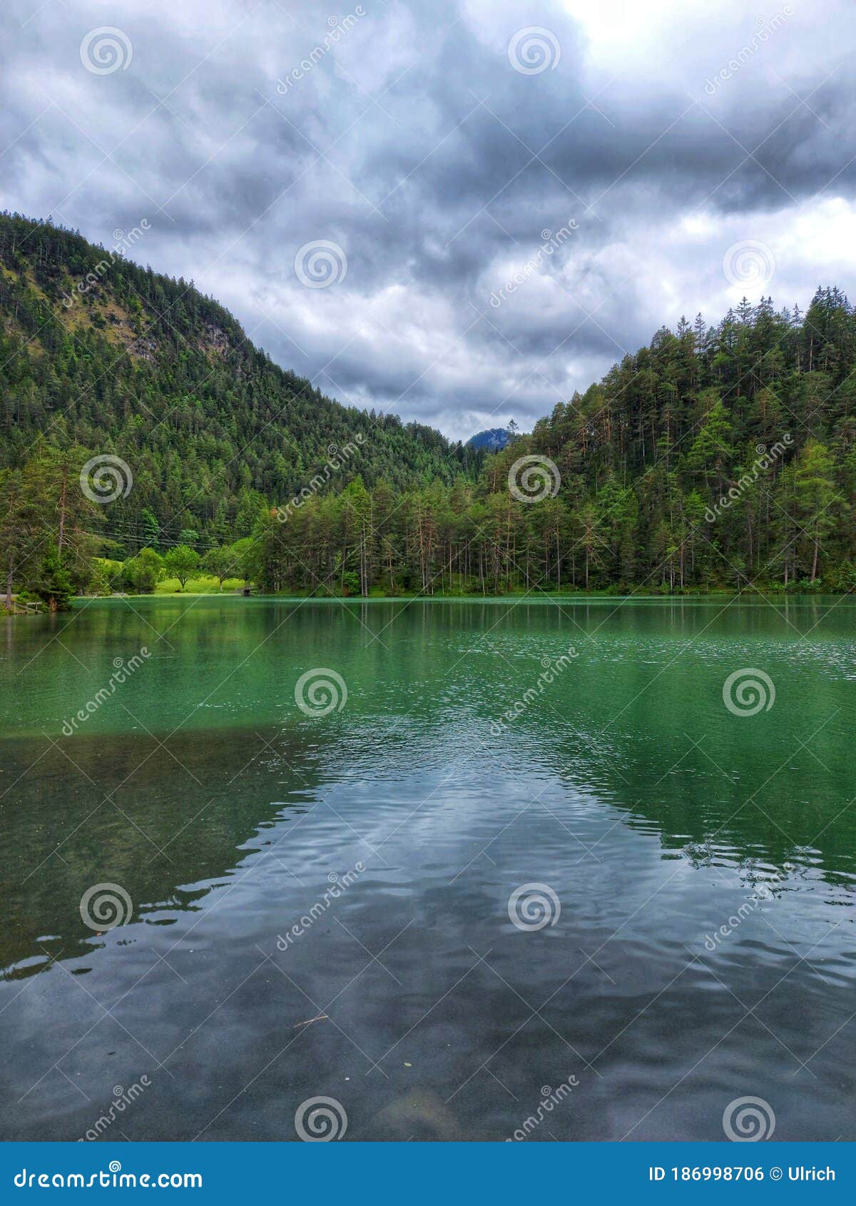 Green Alpine Lake stock photo. Image of nature, green - 186998706