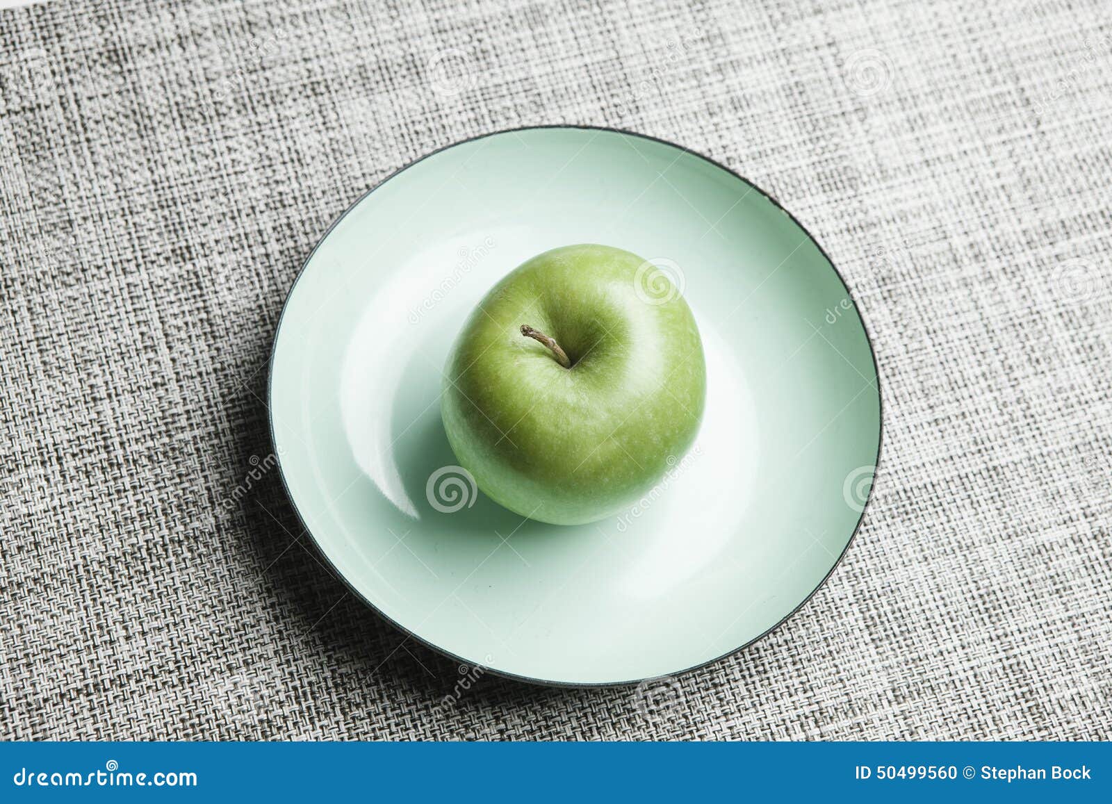 Green apple on plate stock photo. Image of textile, plates - 50499560