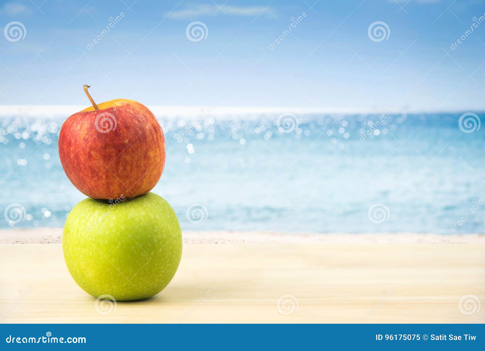 Green Apple and Red Apples on a Table,Beach Background. Stock Image ...
